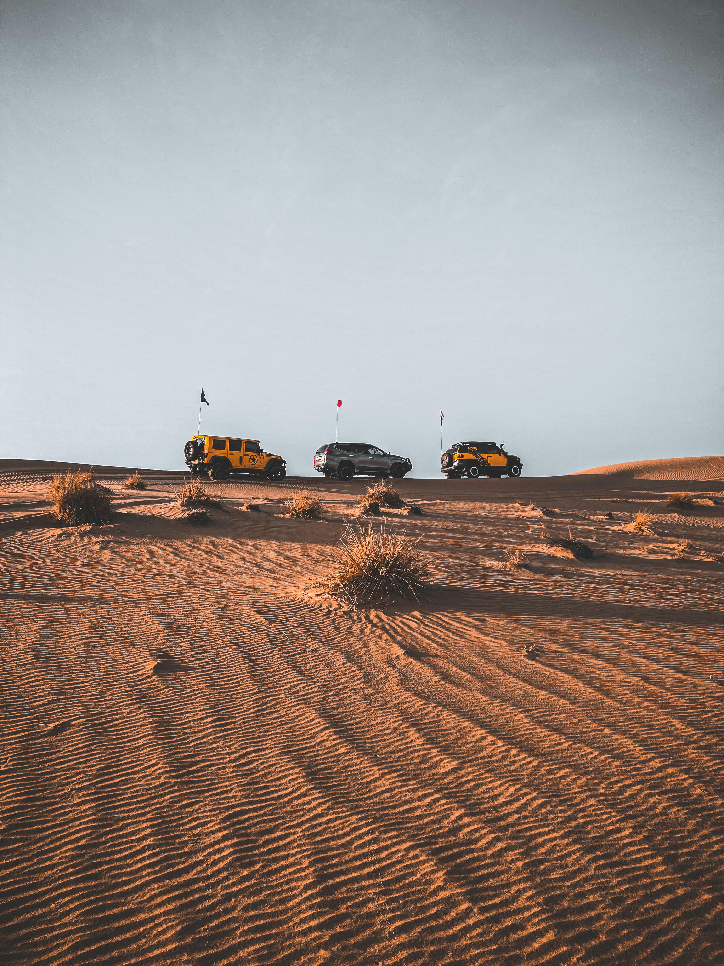 Scenery of car riding over desert dunes · Free Stock Photo