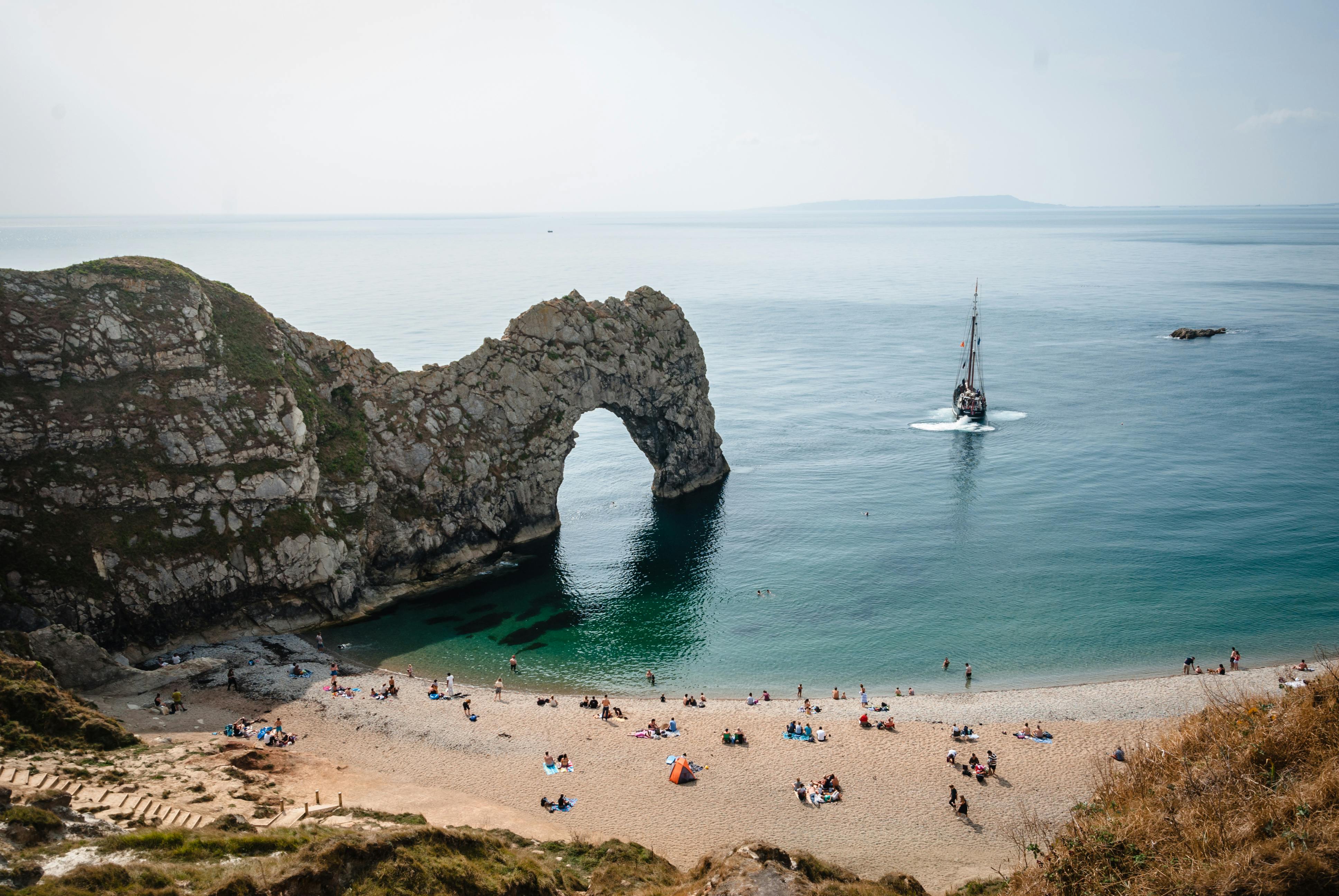 Gray Cave Near Body of Water · Free Stock Photo
