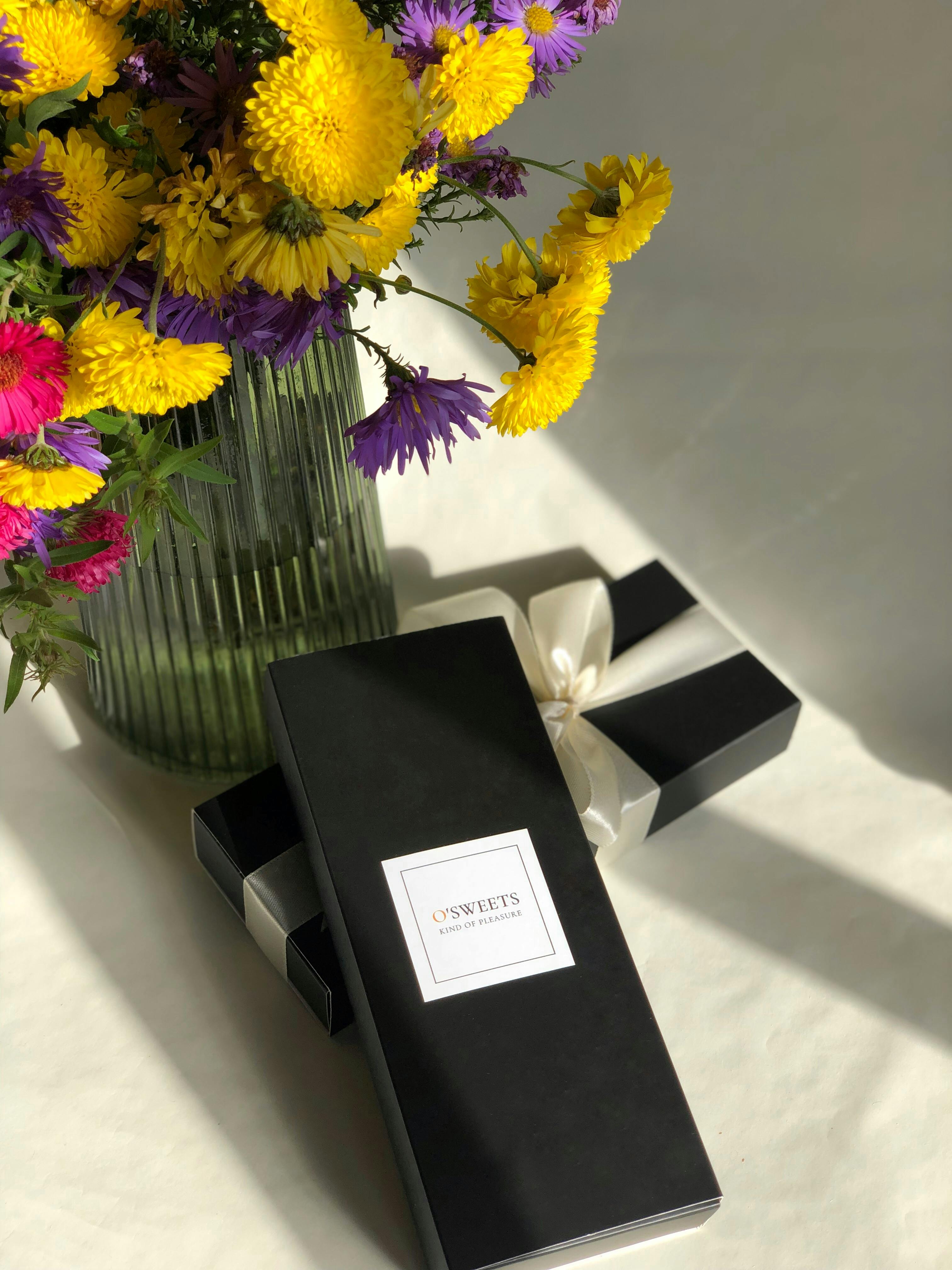 Flowers on Glass Vase and Black Gift Boxes · Free Stock Photo
