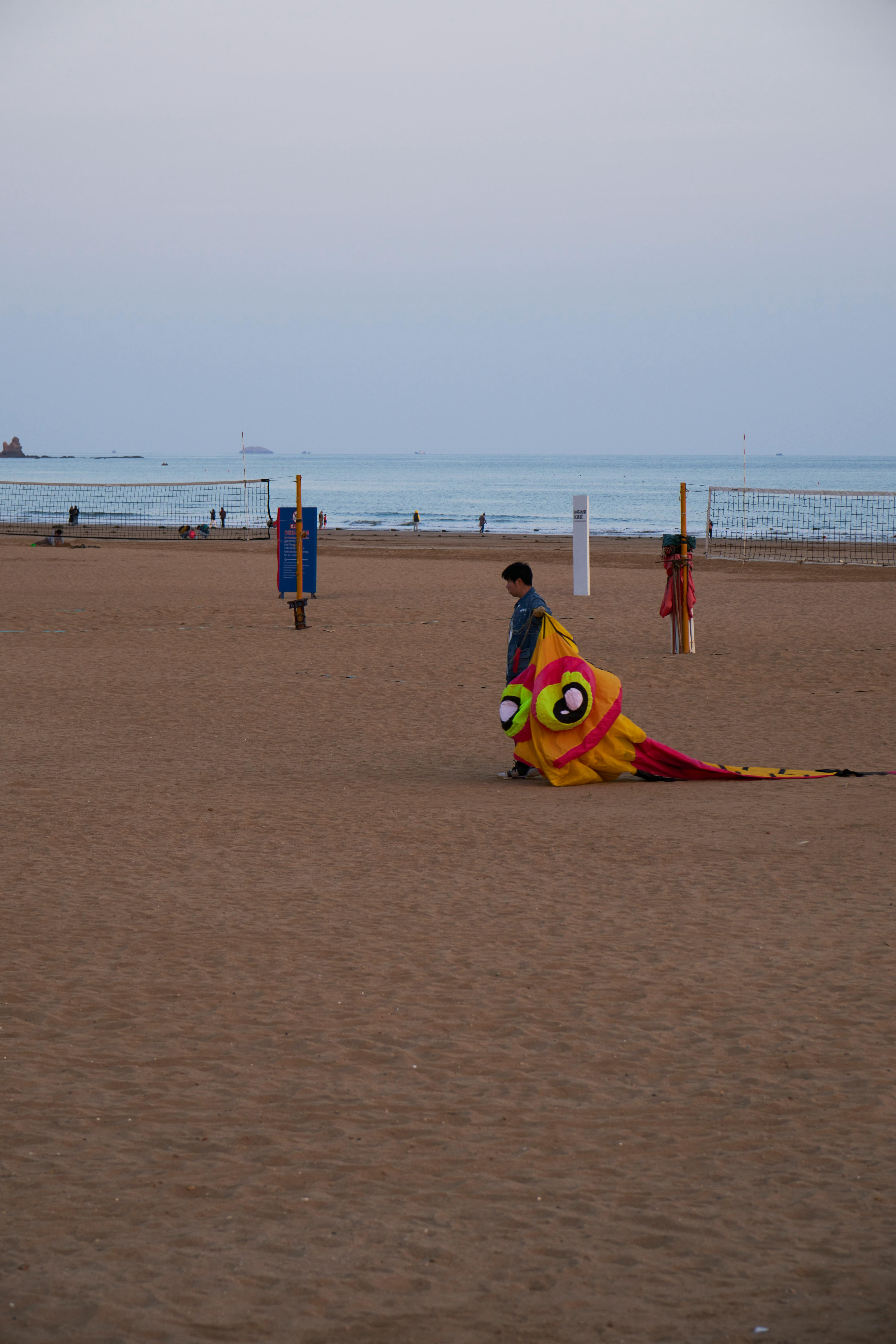 Boy Dragging a Kite Down the Beach · Free Stock Photo