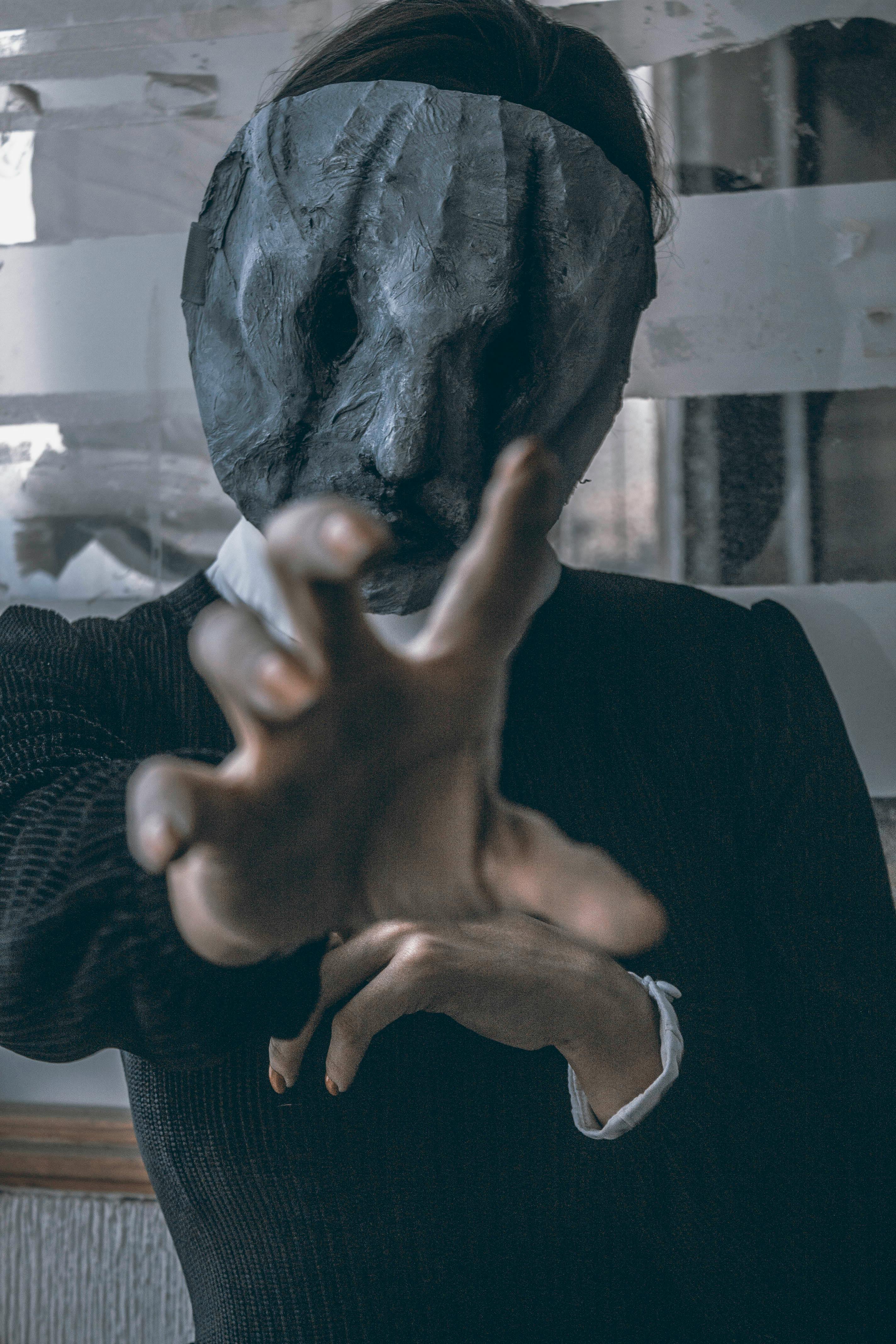 Portrait of Person in Mask with Hands · Free Stock Photo