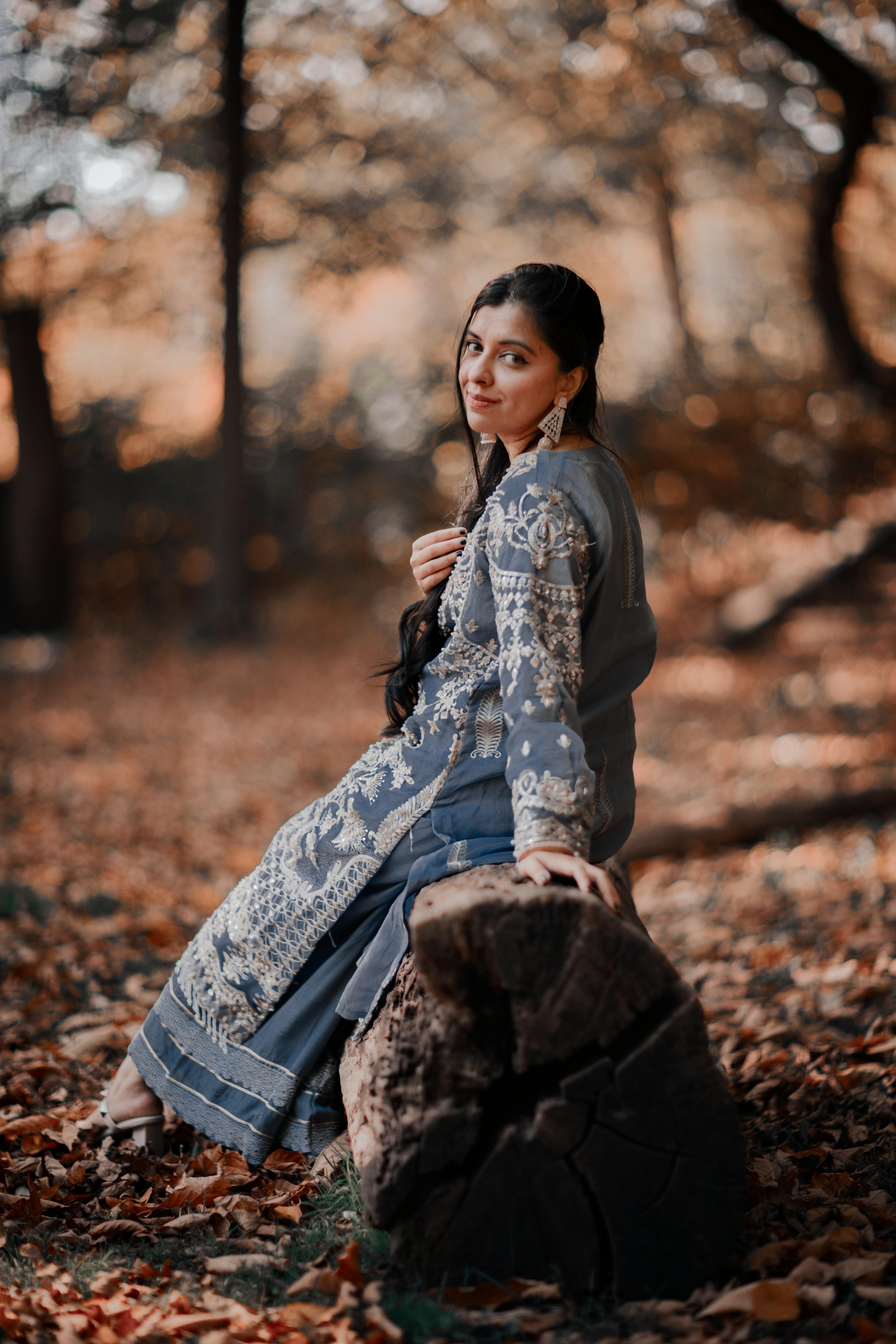 A Woman Sitting on the Tree Log · Free Stock Photo