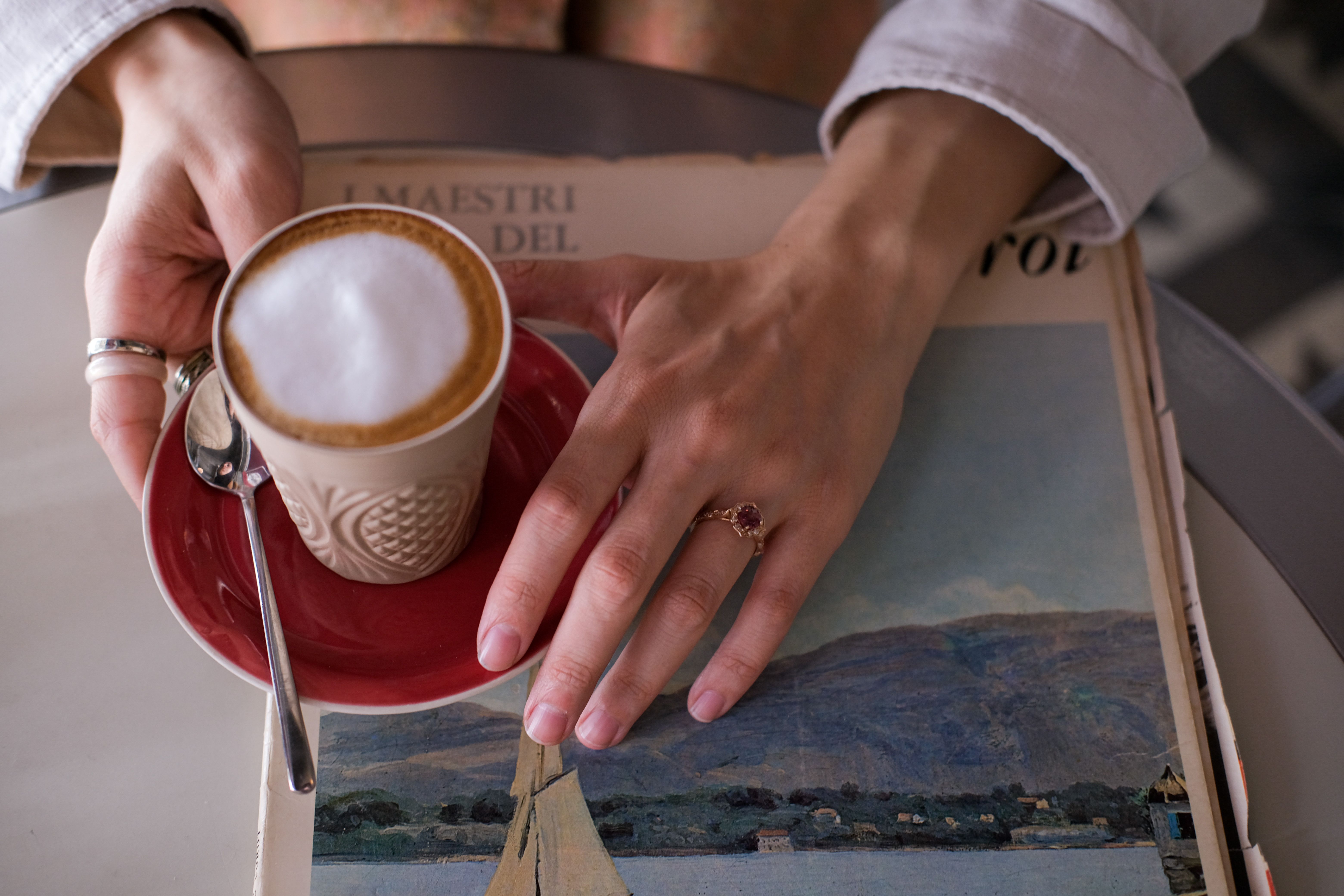A Person's Hand beside a Coffee Drink · Free Stock Photo