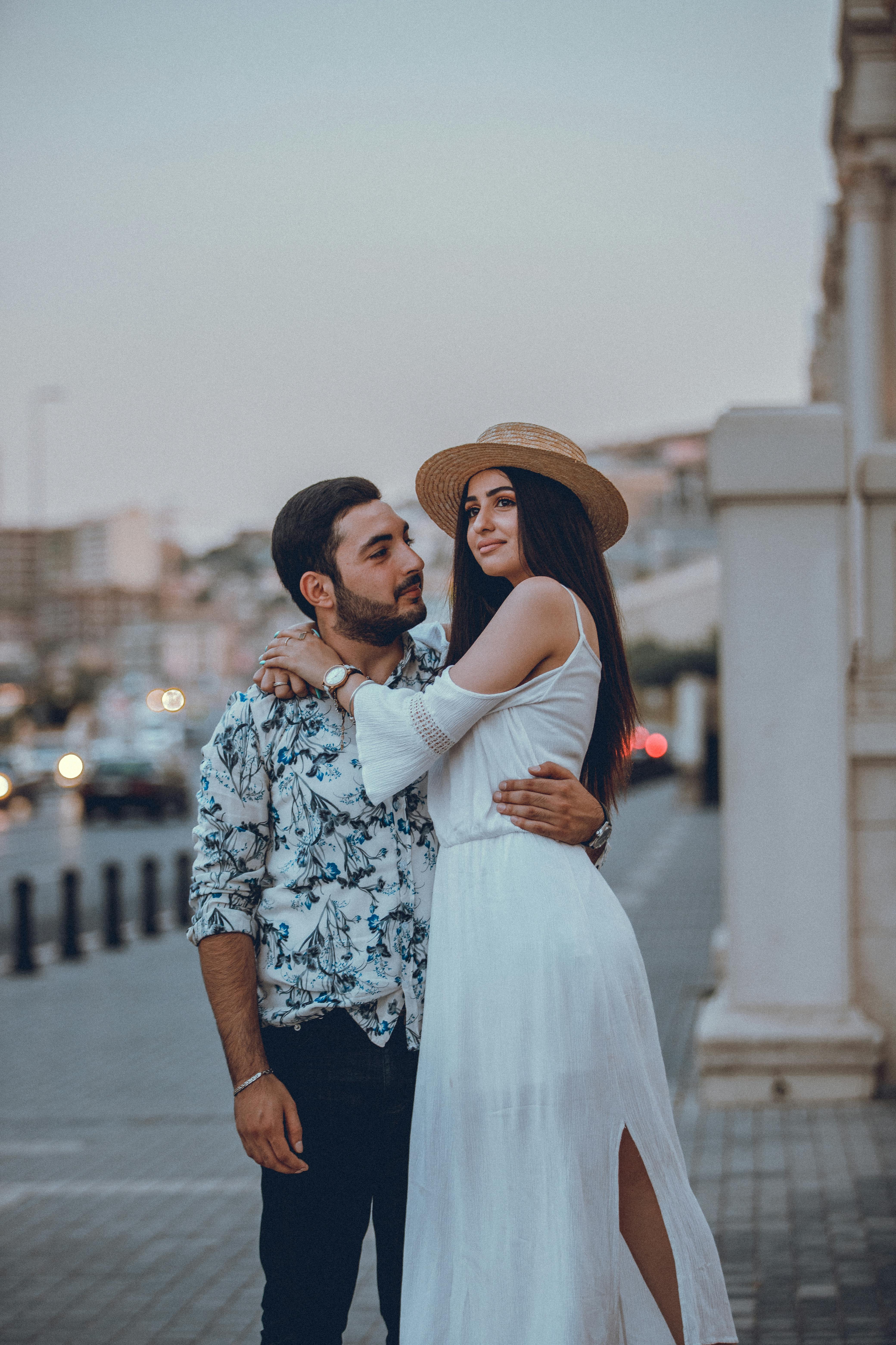 Woman and Man Cuddle on Field · Free Stock Photo