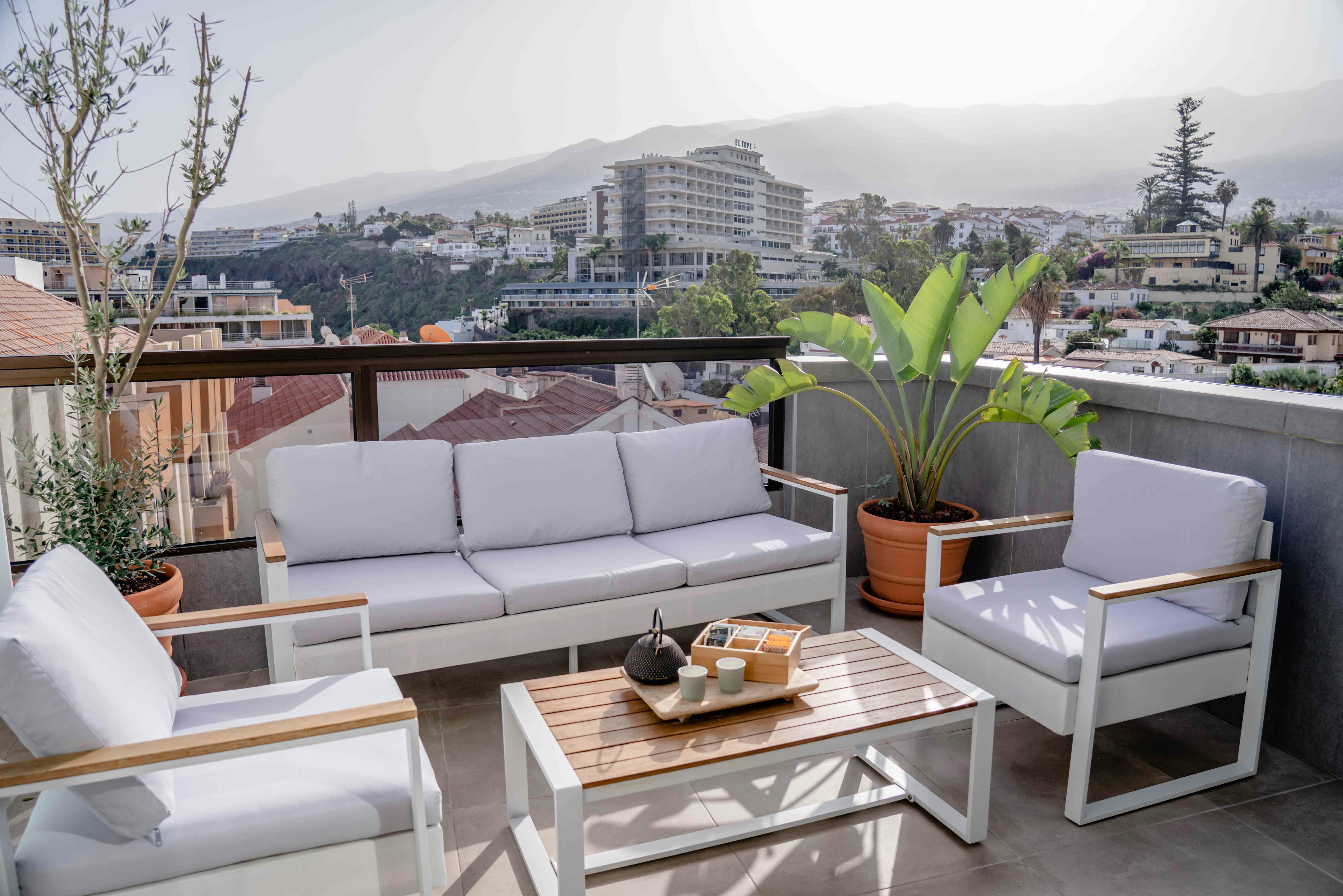 Lounge Area on Balcony above City · Free Stock Photo