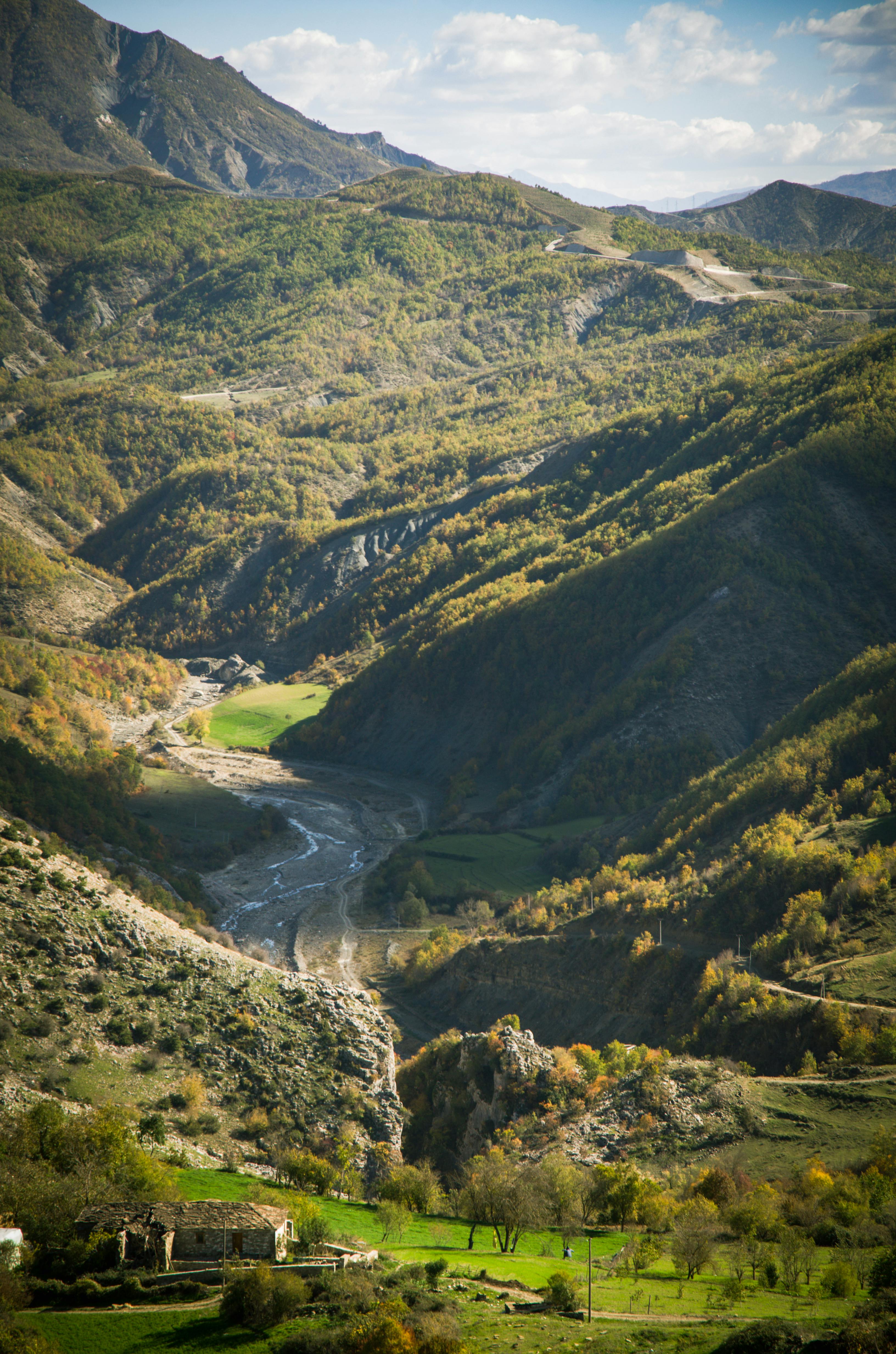 Back View of a Man Standing on the River Bank in Mountains · Free Stock ...