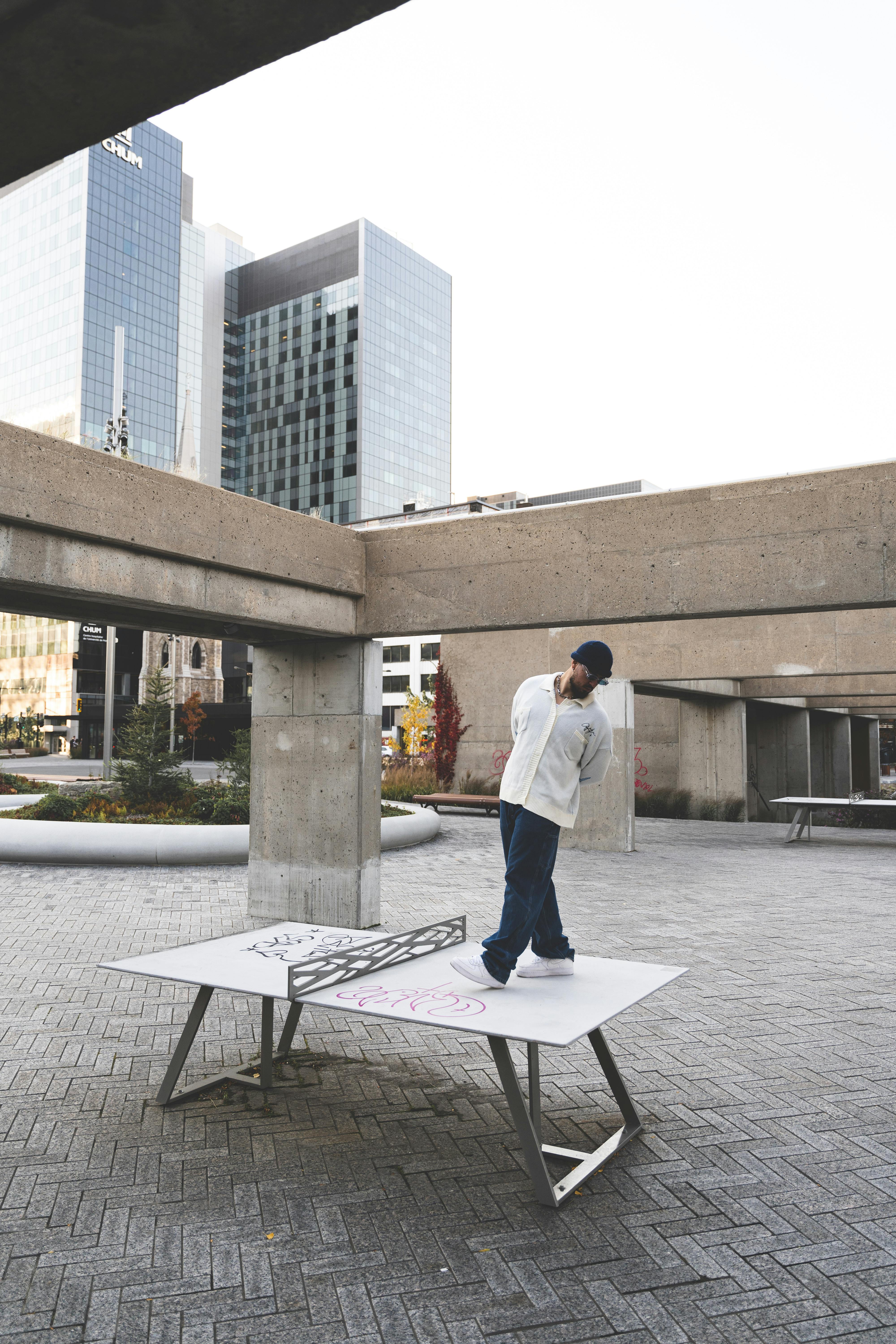 Man Standing by Table with Equipment · Free Stock Photo