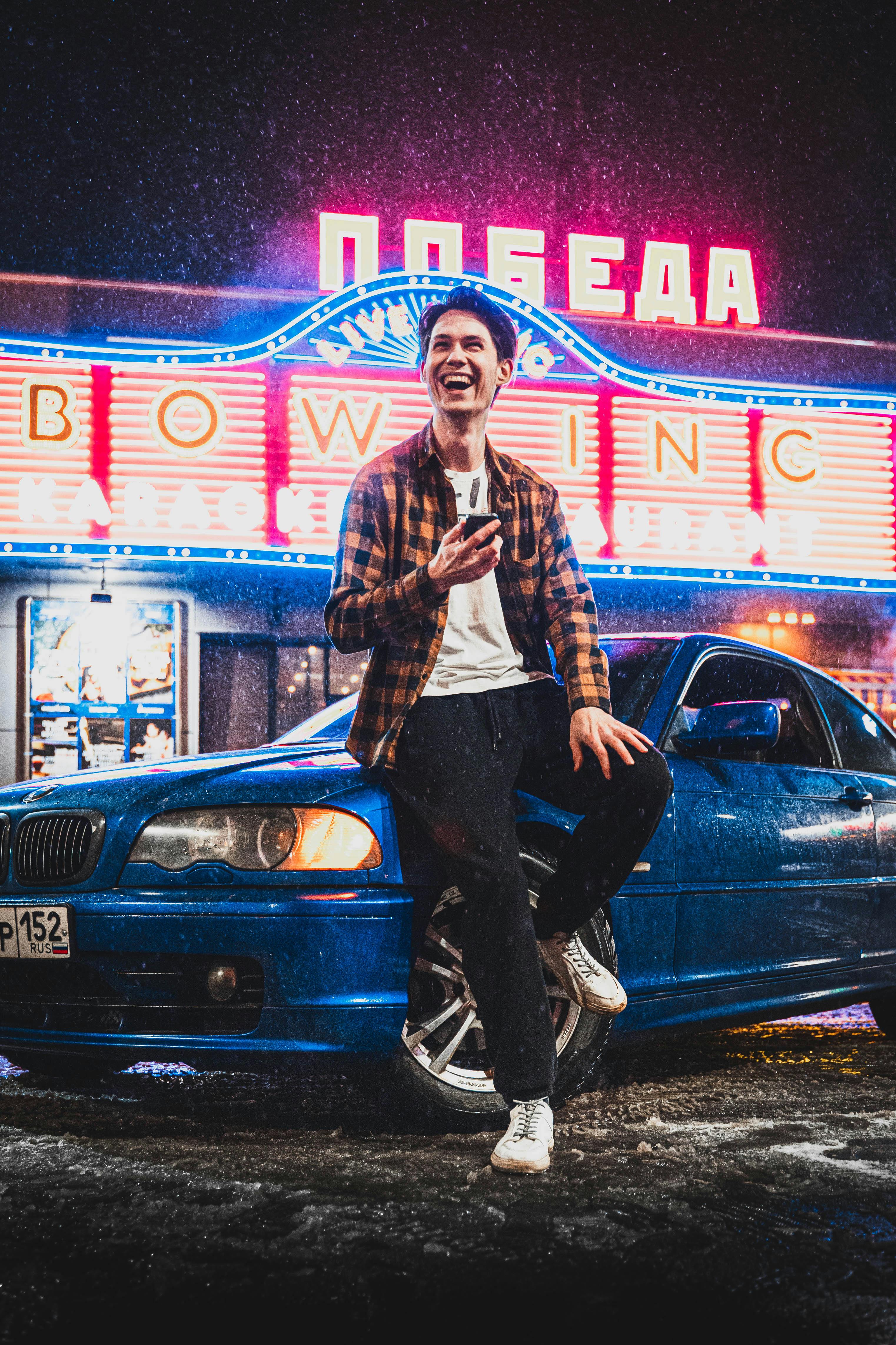 Man Sitting on Blue Car · Free Stock Photo