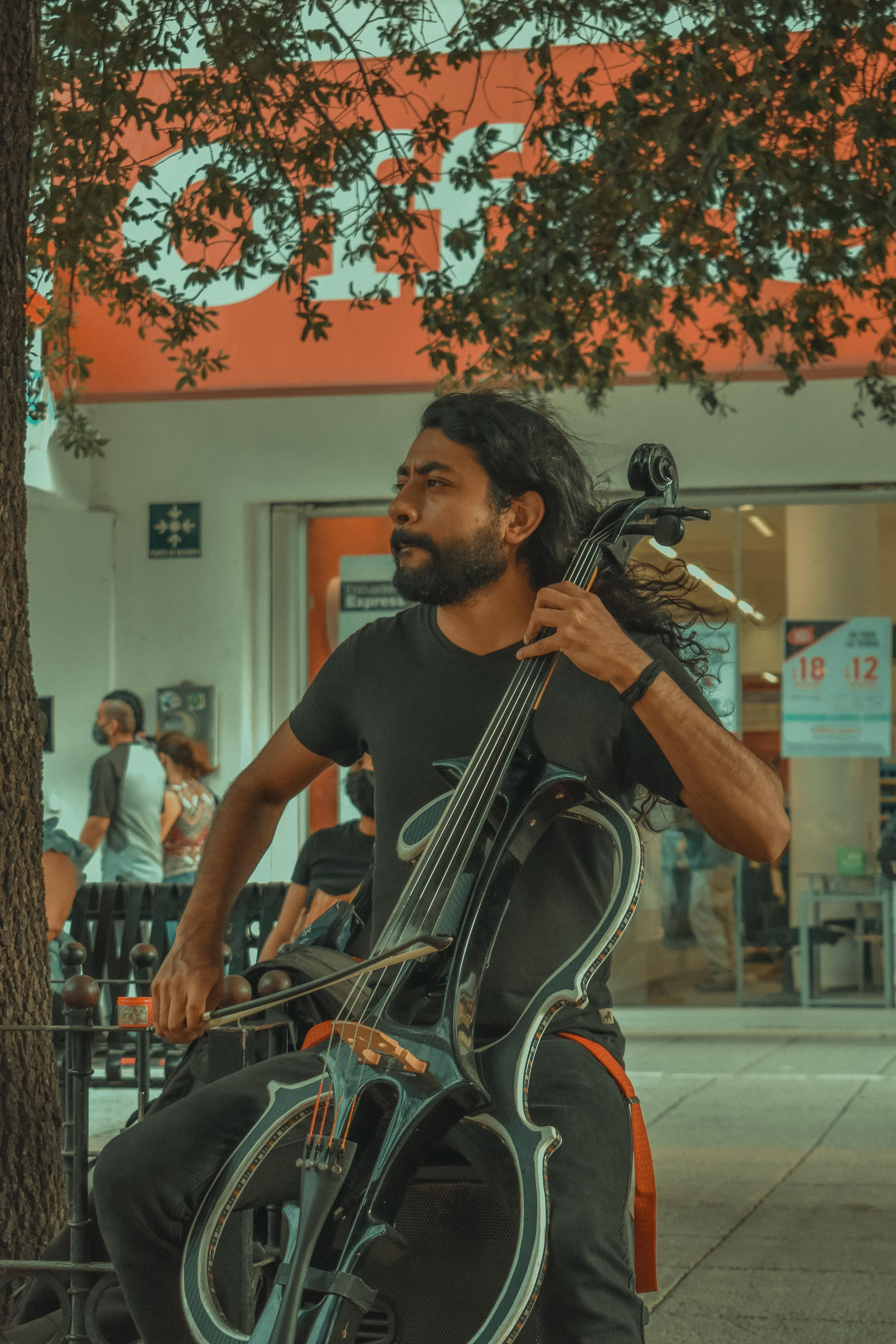 A Man playing Cello on the Street · Free Stock Photo