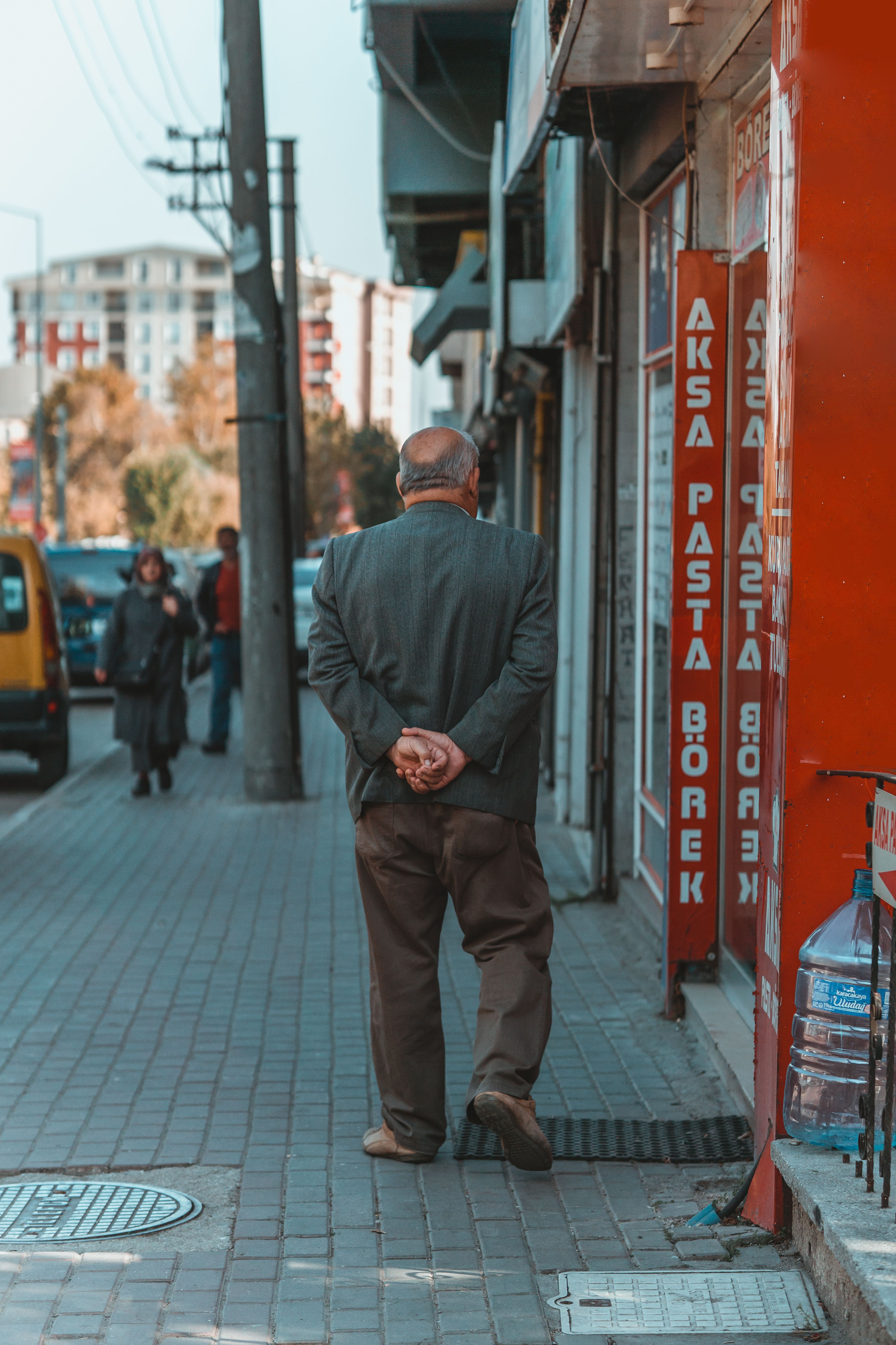 A Man in Gray Suit Walking on the Street · Free Stock Photo
