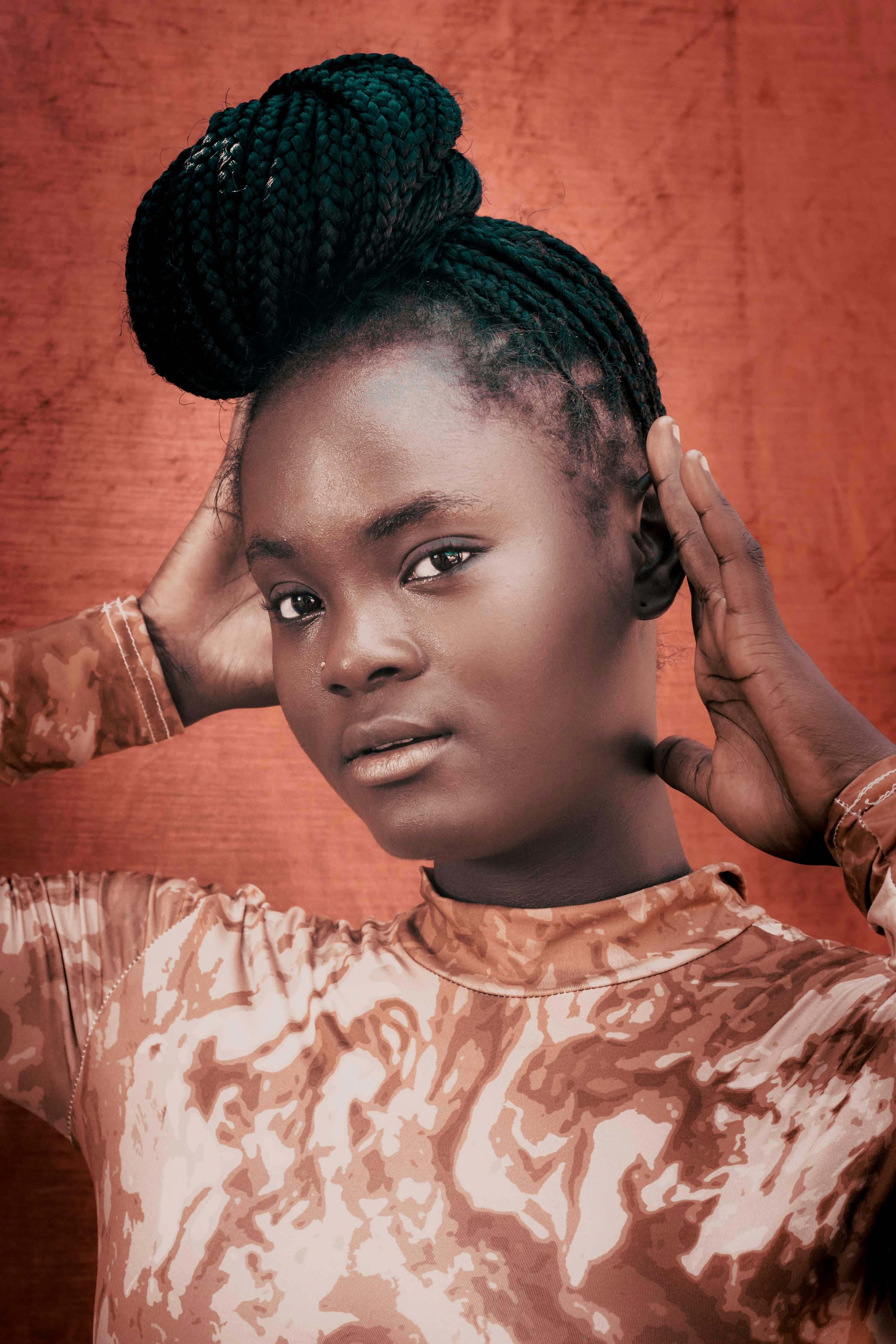 Young Woman Standing with Hands Behind Back · Free Stock Photo