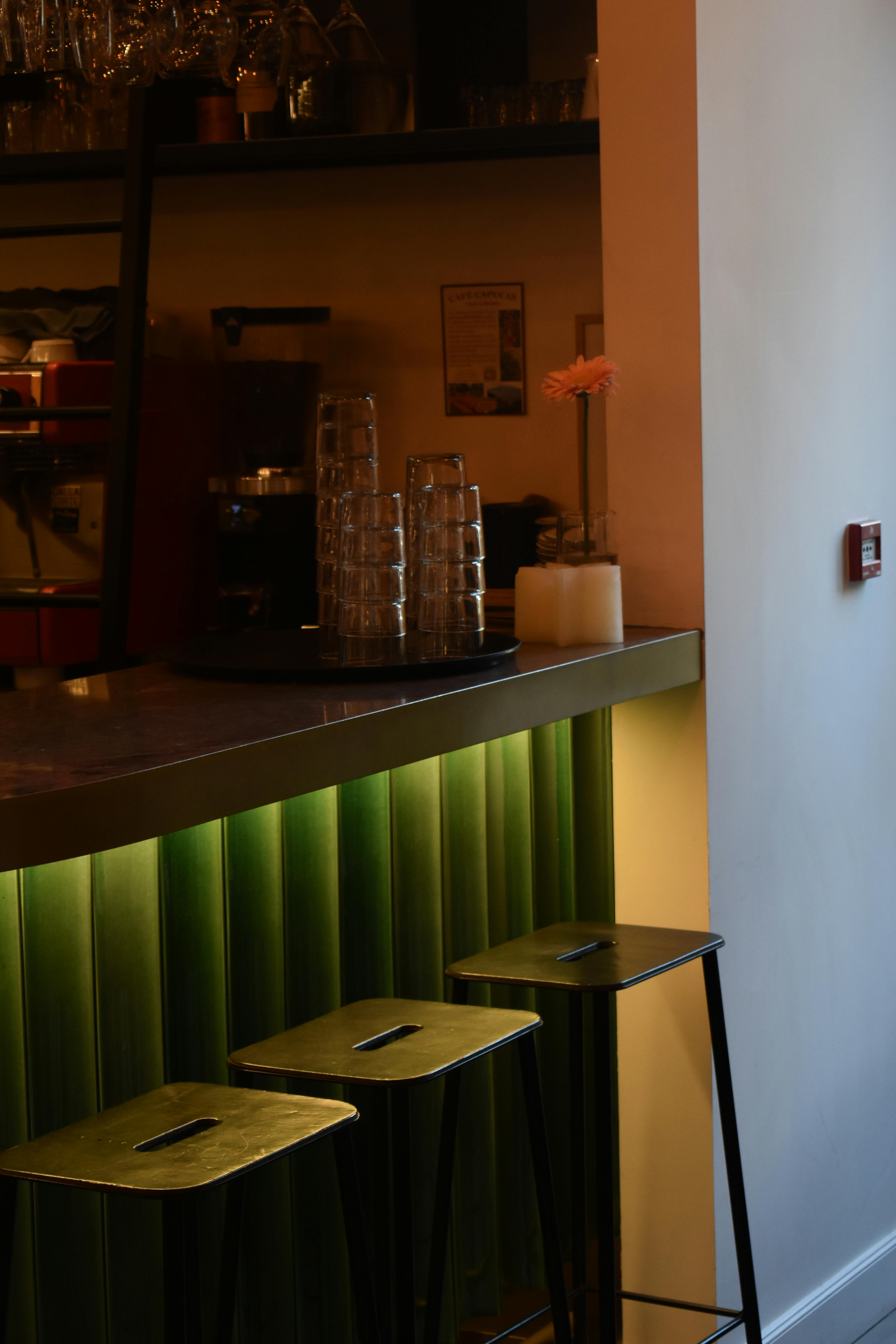 Black Bar Counter with Cozy Leather Stools · Free Stock Photo