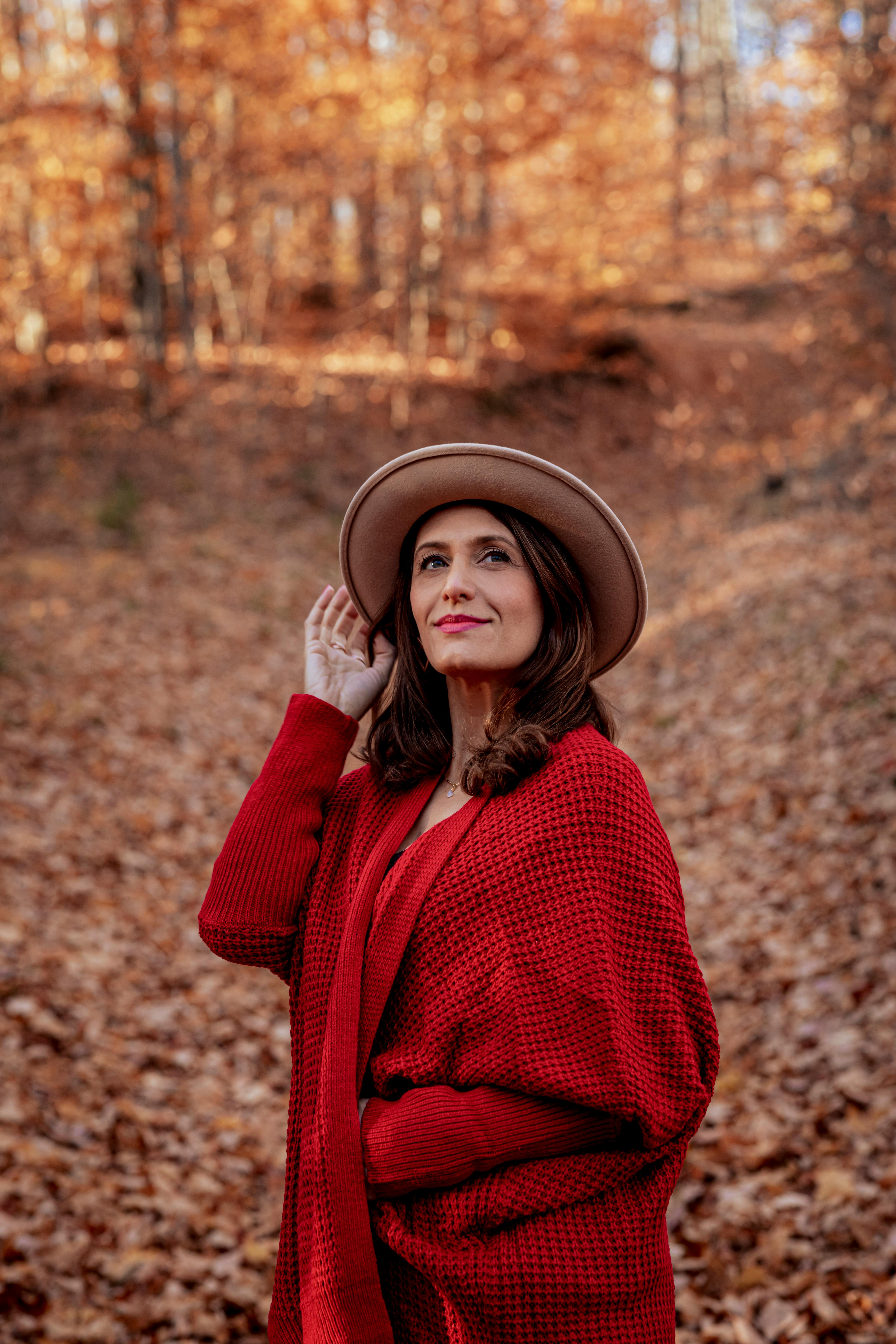 A Woman in Red Dress Standing Near Green Plants · Free Stock Photo