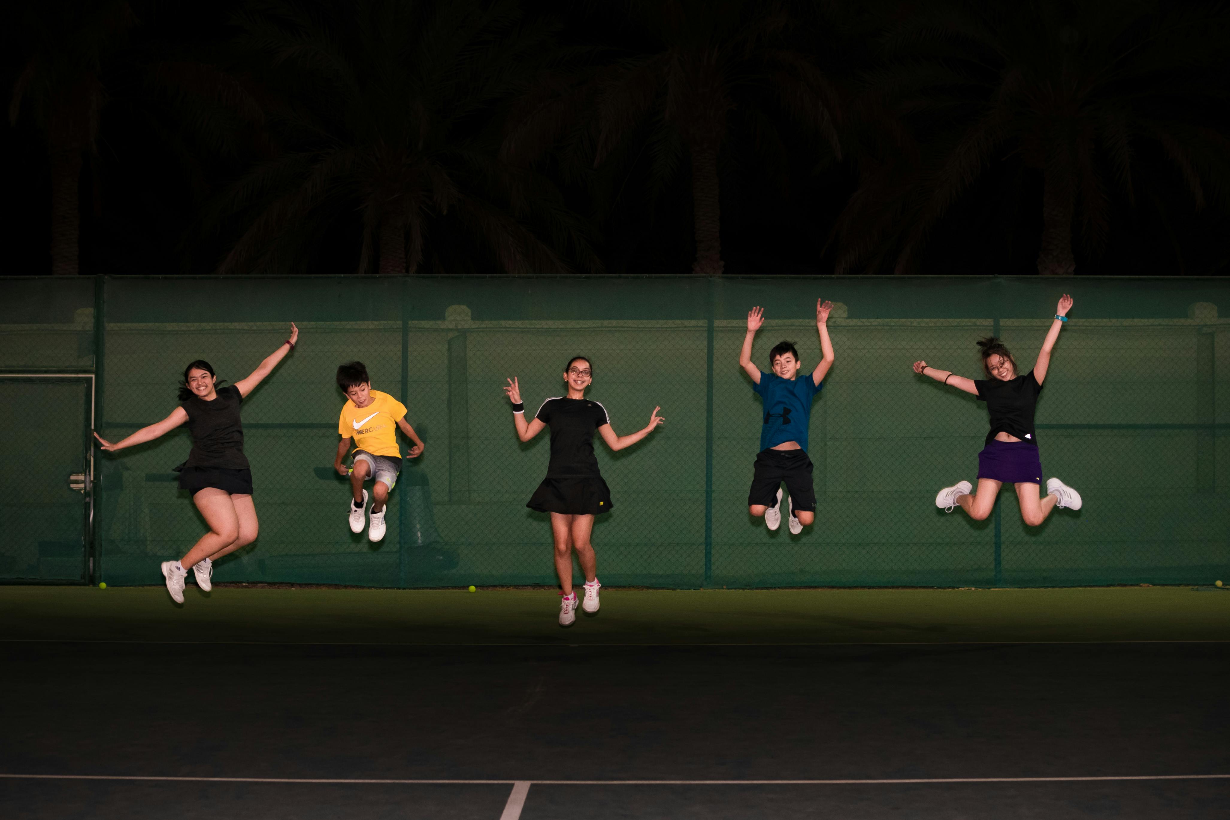 A Jump Shot Photo of a Group of People · Free Stock Photo