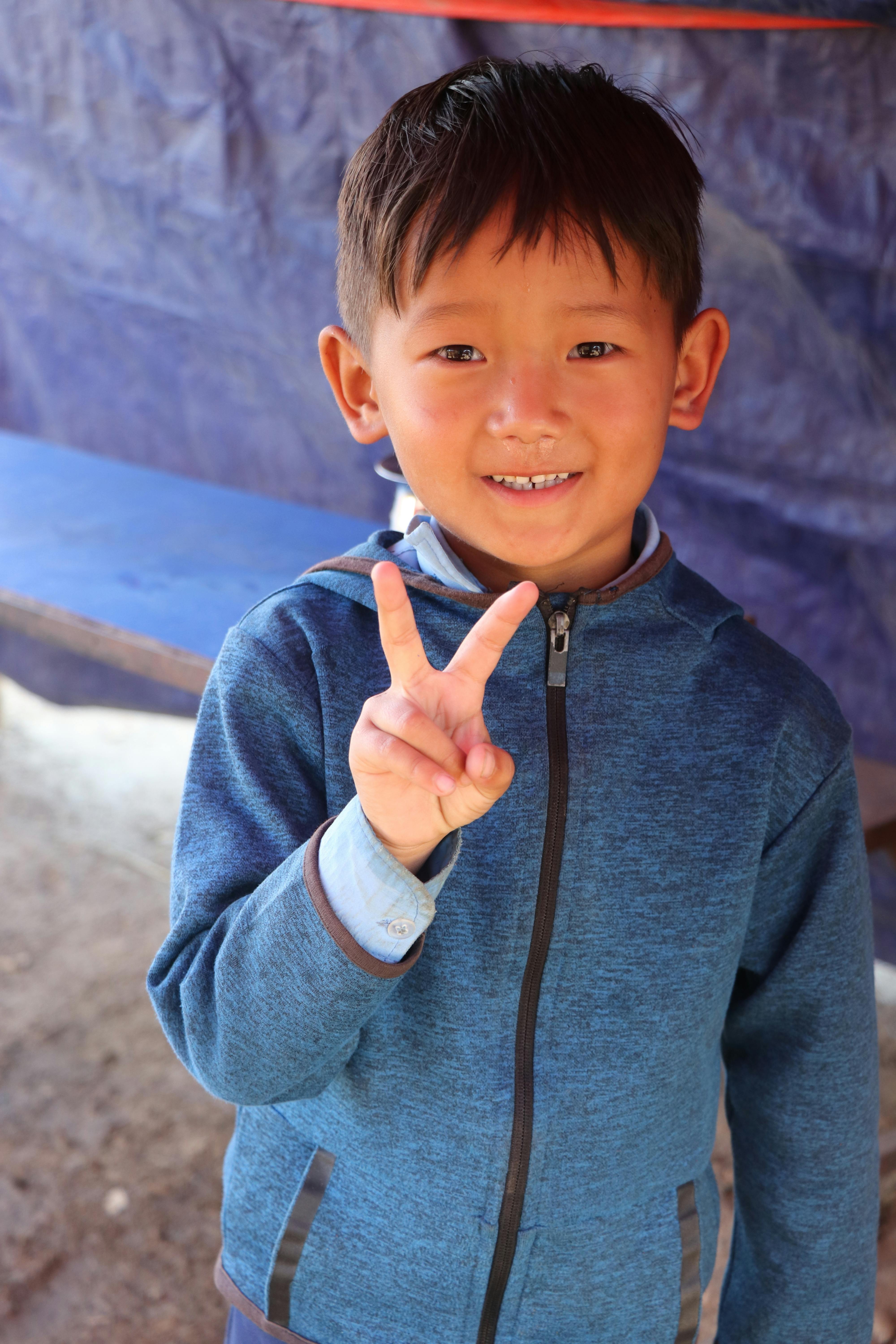 Close-Up Shot of a Boy Wearing Blue Jacket · Free Stock Photo