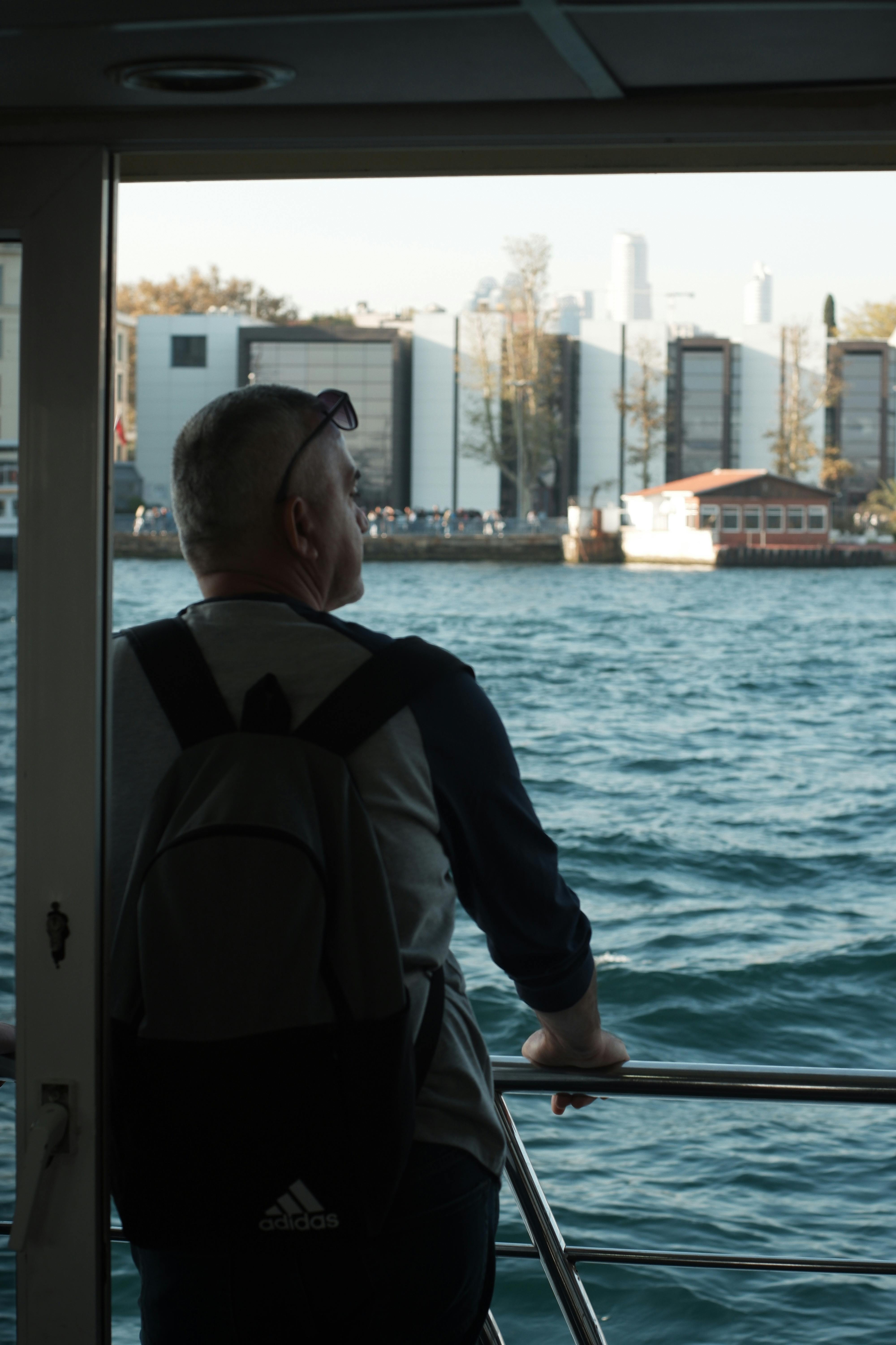 Man on Ship Looking at Sea · Free Stock Photo