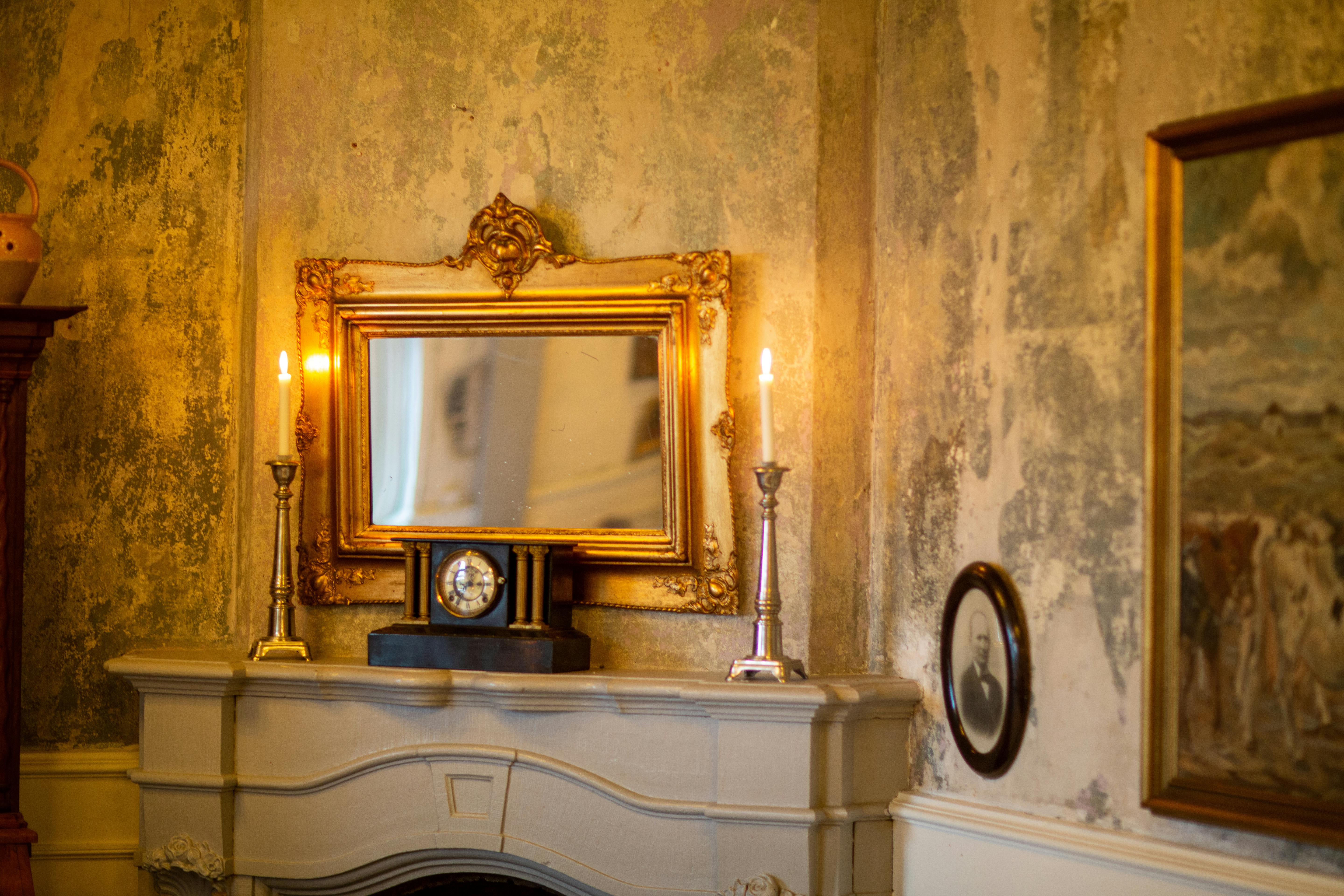 A Mirror and Lighted Candles over a Fireplace · Free Stock Photo