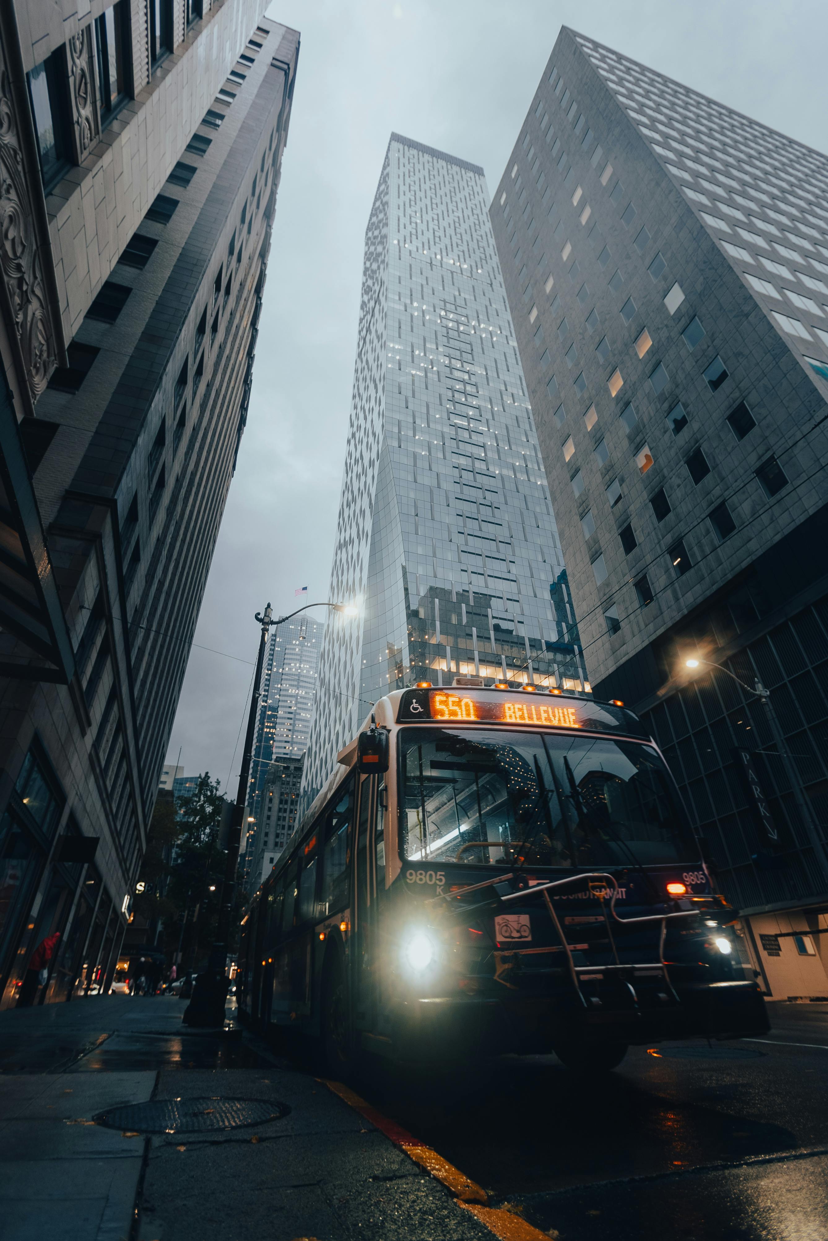 Bus Passing City Buildings · Free Stock Photo