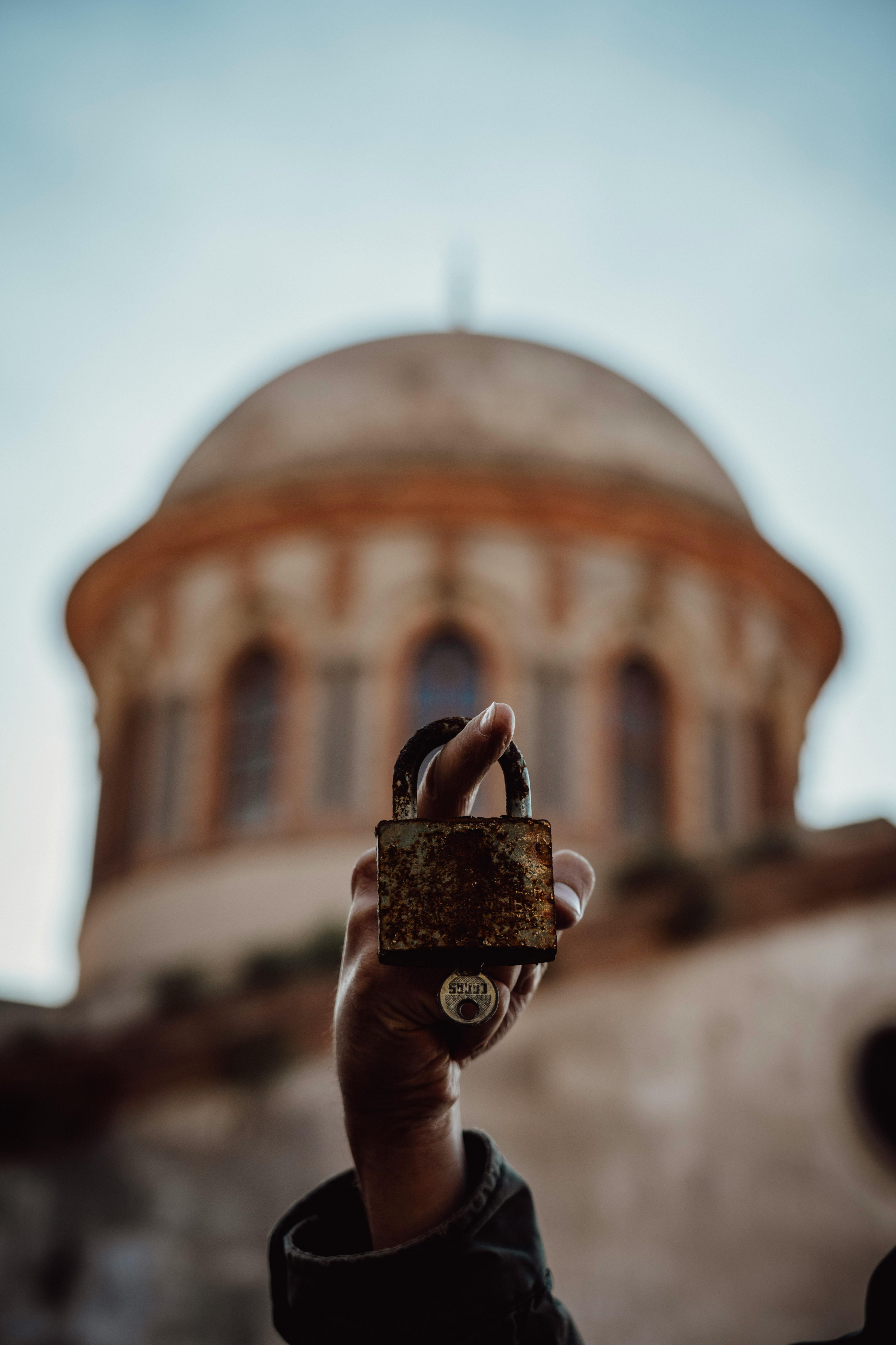 Close-Up Shot of a Person Holding a Padlock · Free Stock Photo