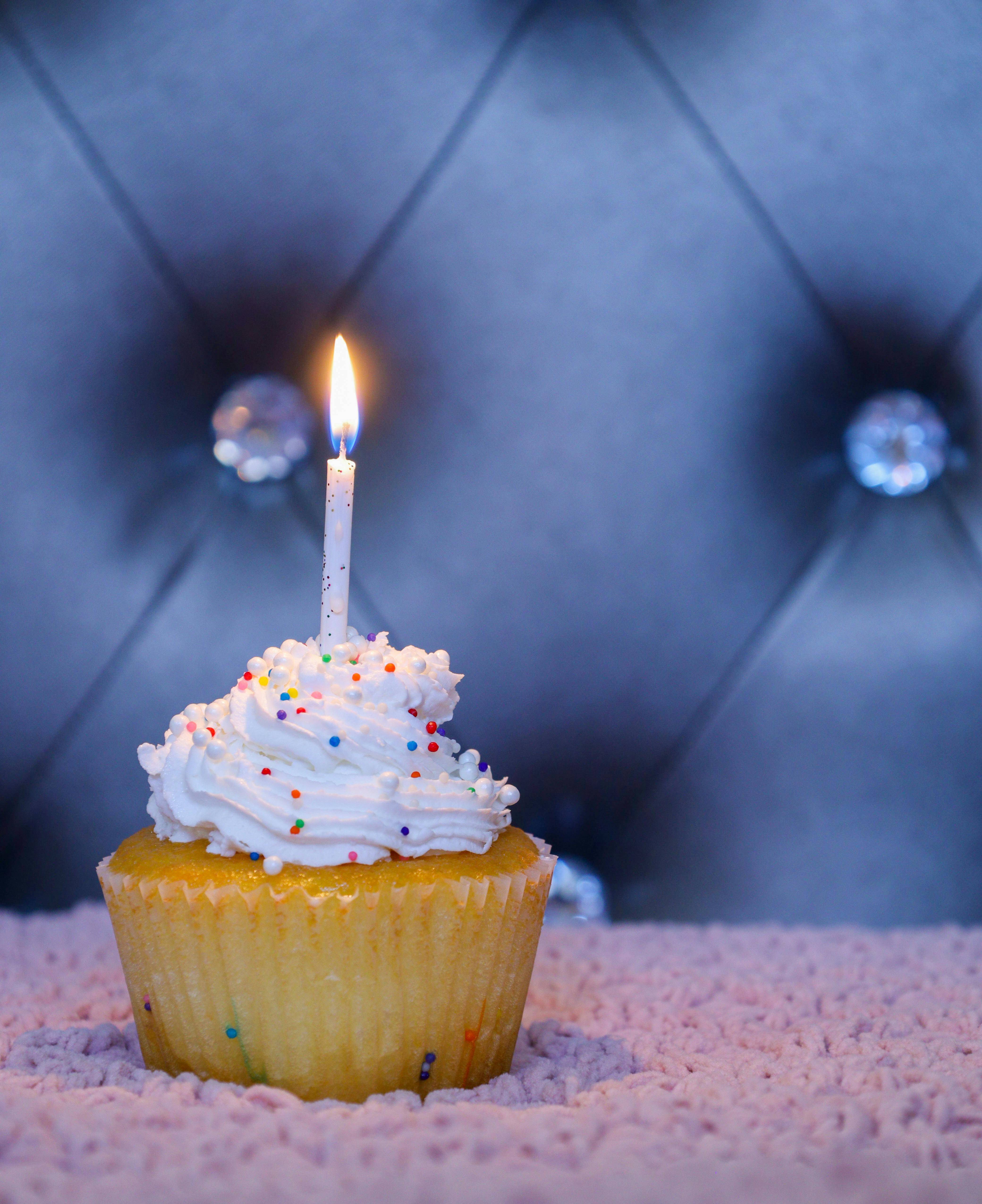 Close-Up Shot of a Delicious Cupcake with Icing and Lighted Candle on ...