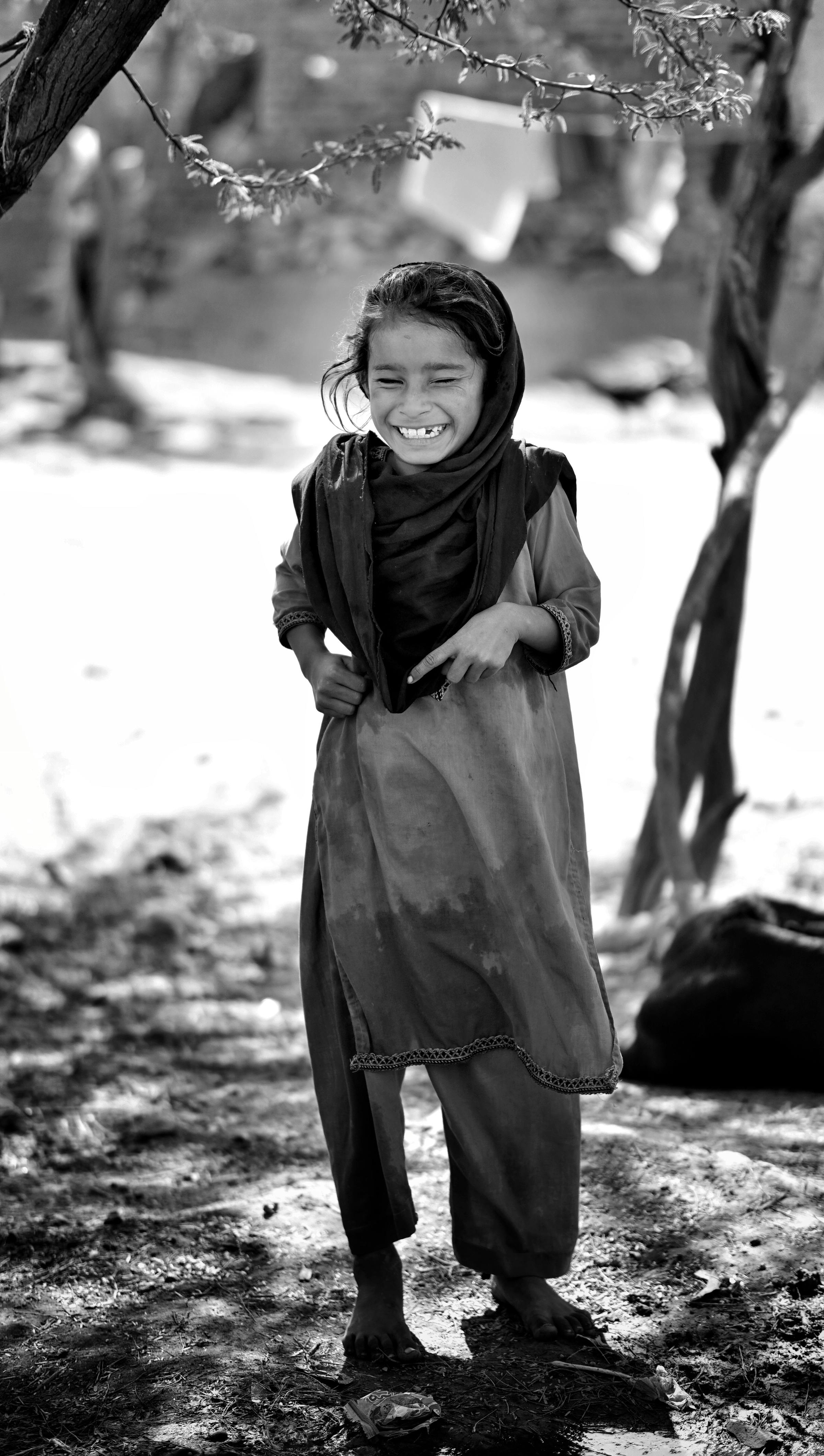 Girl Standing and Smelling Fruit from Tree · Free Stock Photo