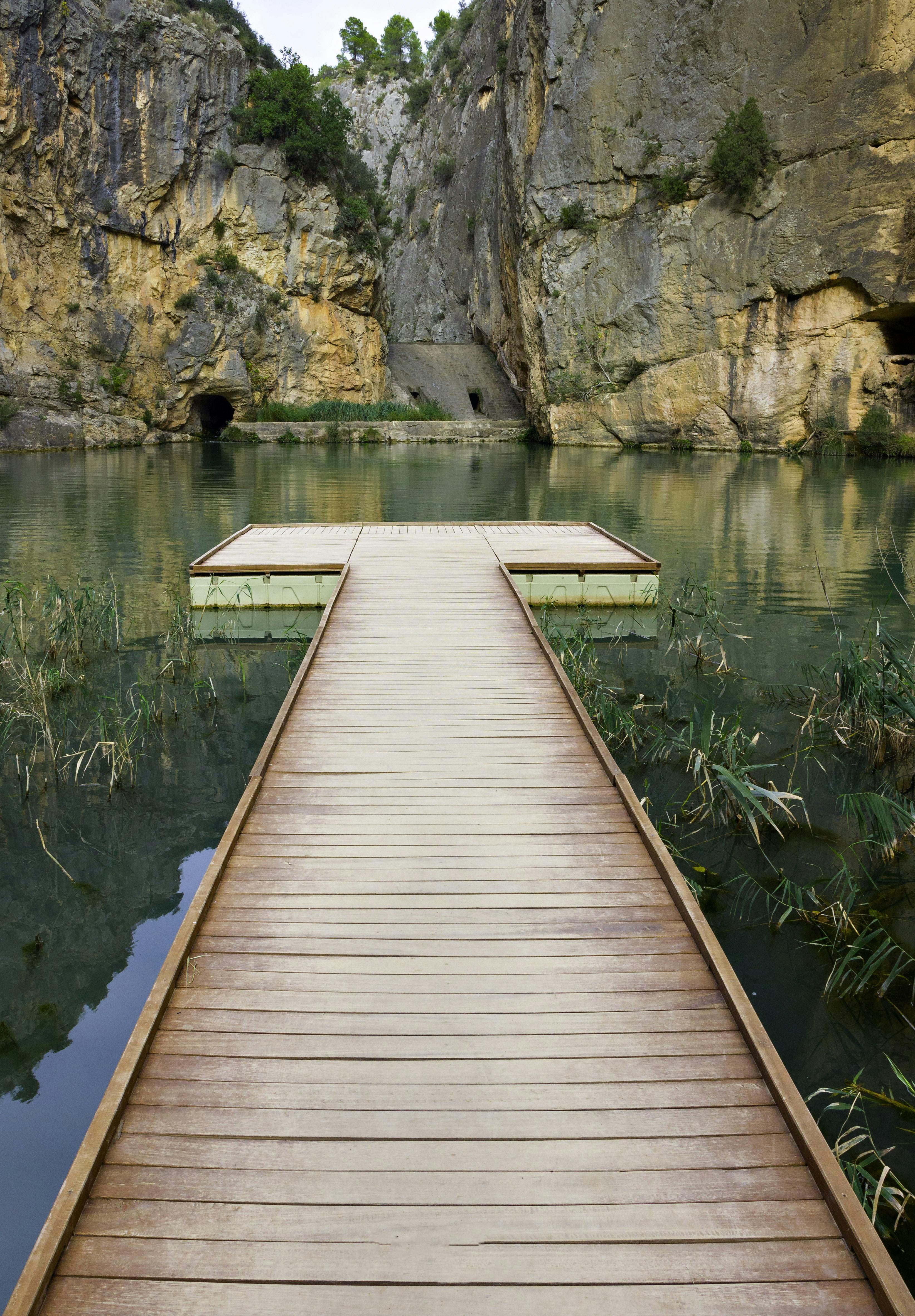 A Wooden Pier on a Lake Surrounded by Mountains · Free Stock Photo