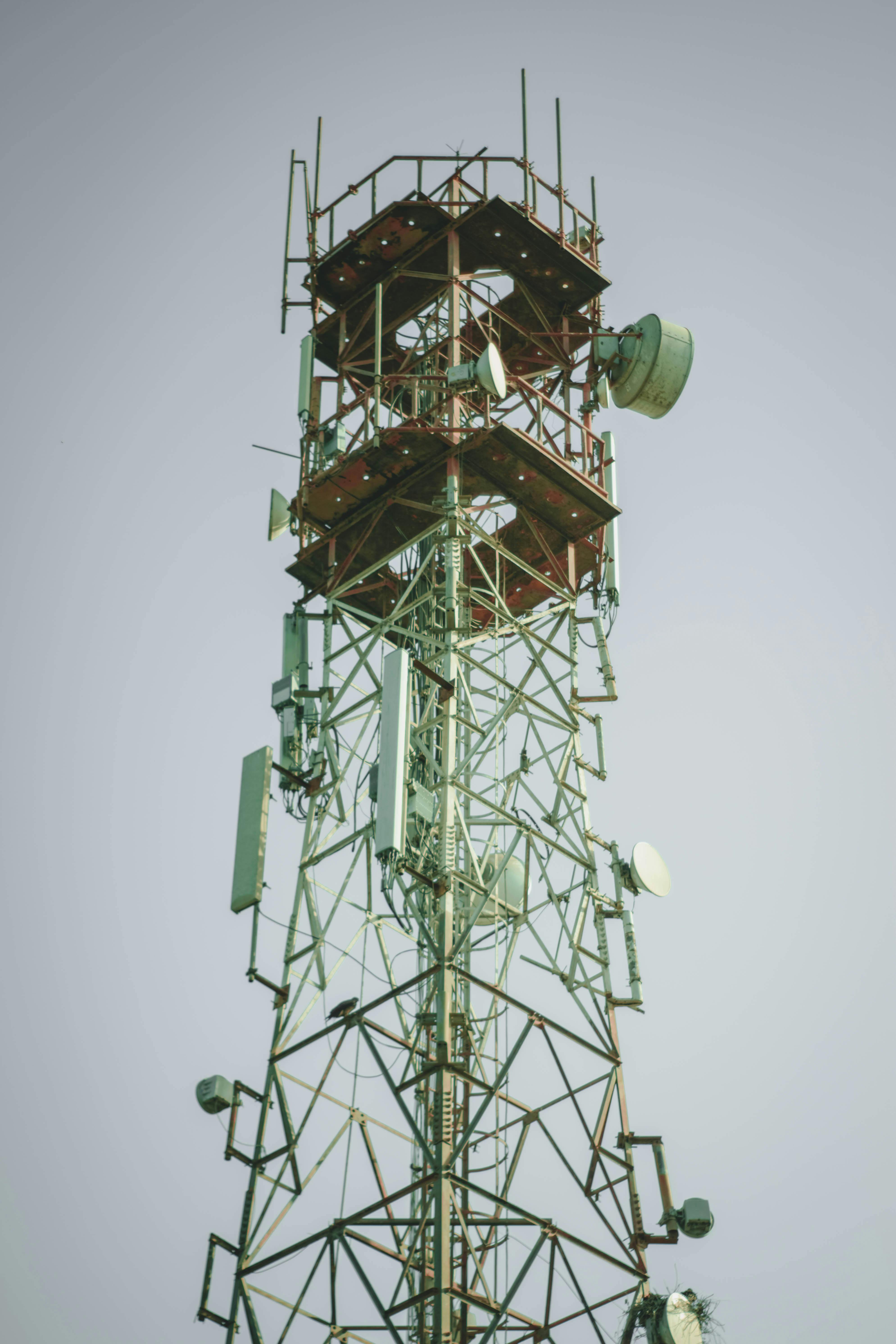 A Steel Satellite Tower Under Gray Sky · Free Stock Photo