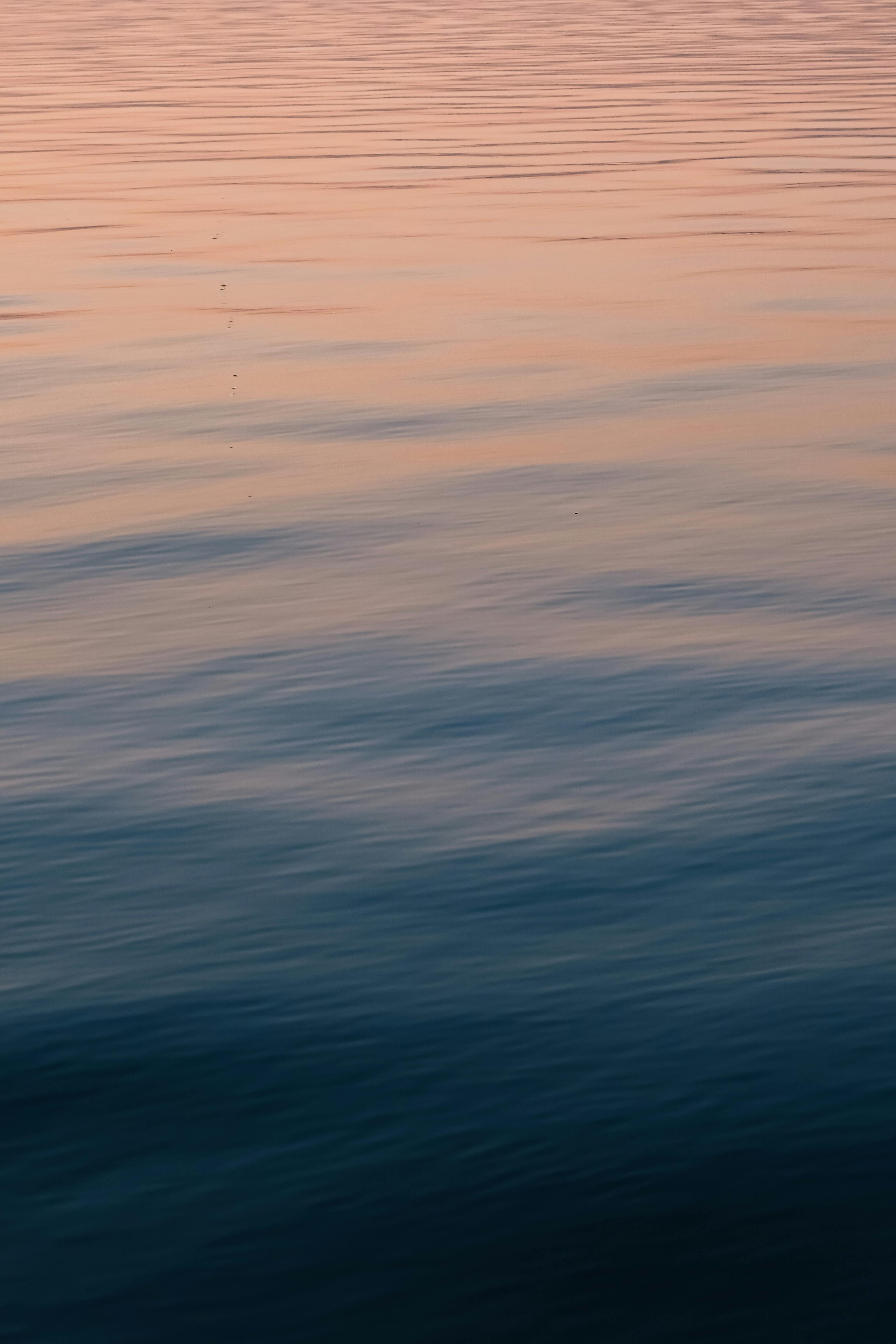 Smooth Water Surface with a Reflection of a Pink Sunset Sky · Free ...