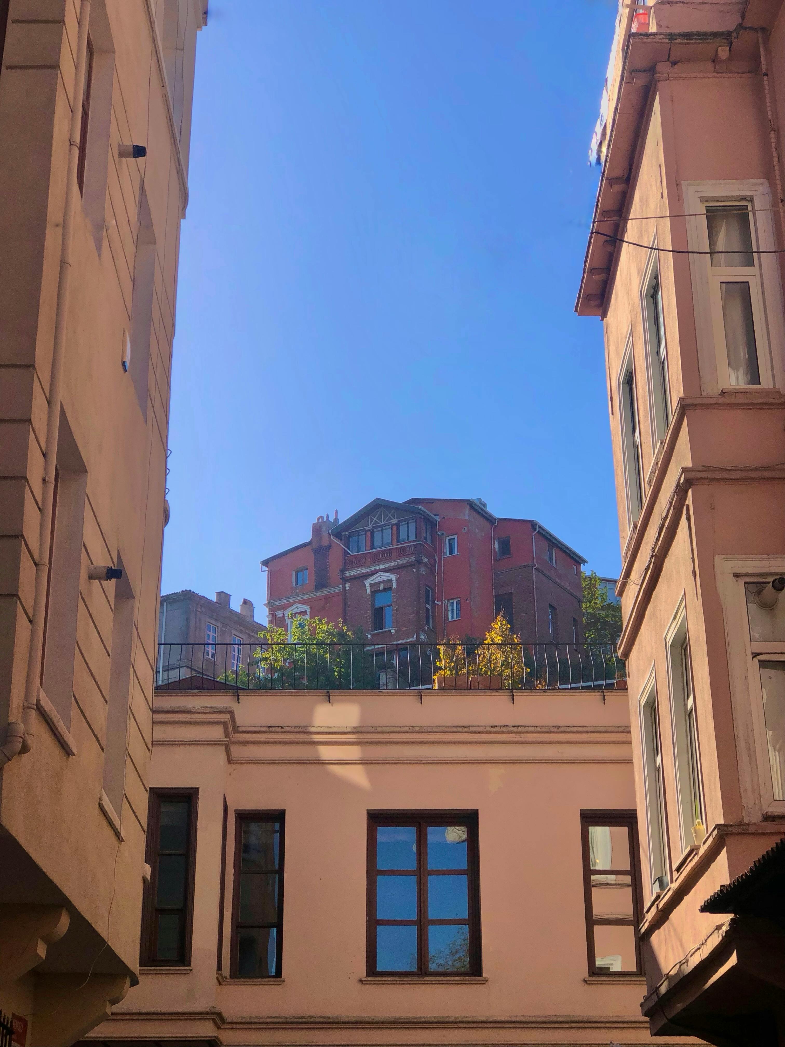 Blue and White Building Under a Clear Sky · Free Stock Photo