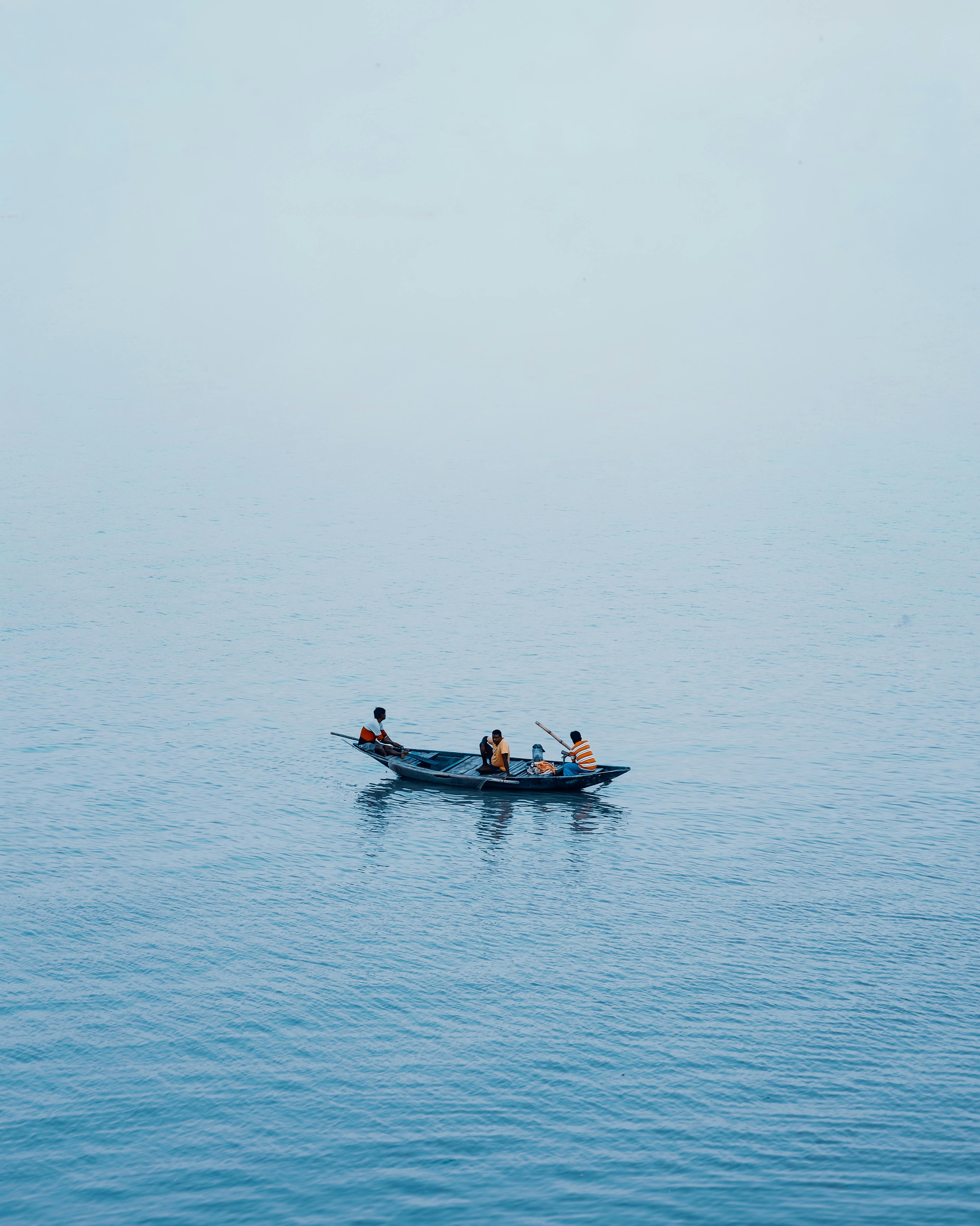 A Group of Person Riding a Boat on Body of Water · Free Stock Photo