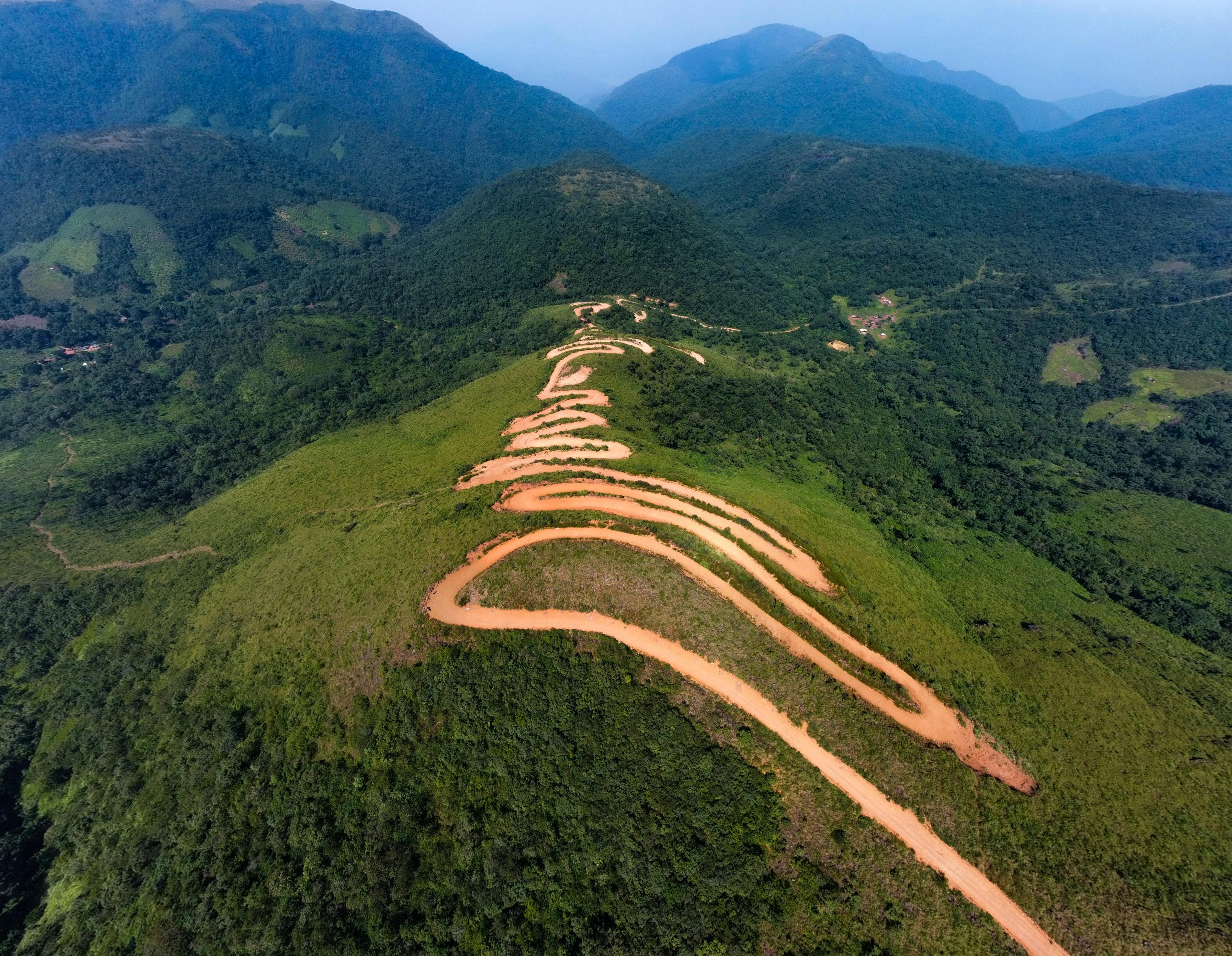 A Brown Snaky Pathway on Top of a Green Mountain · Free Stock Photo