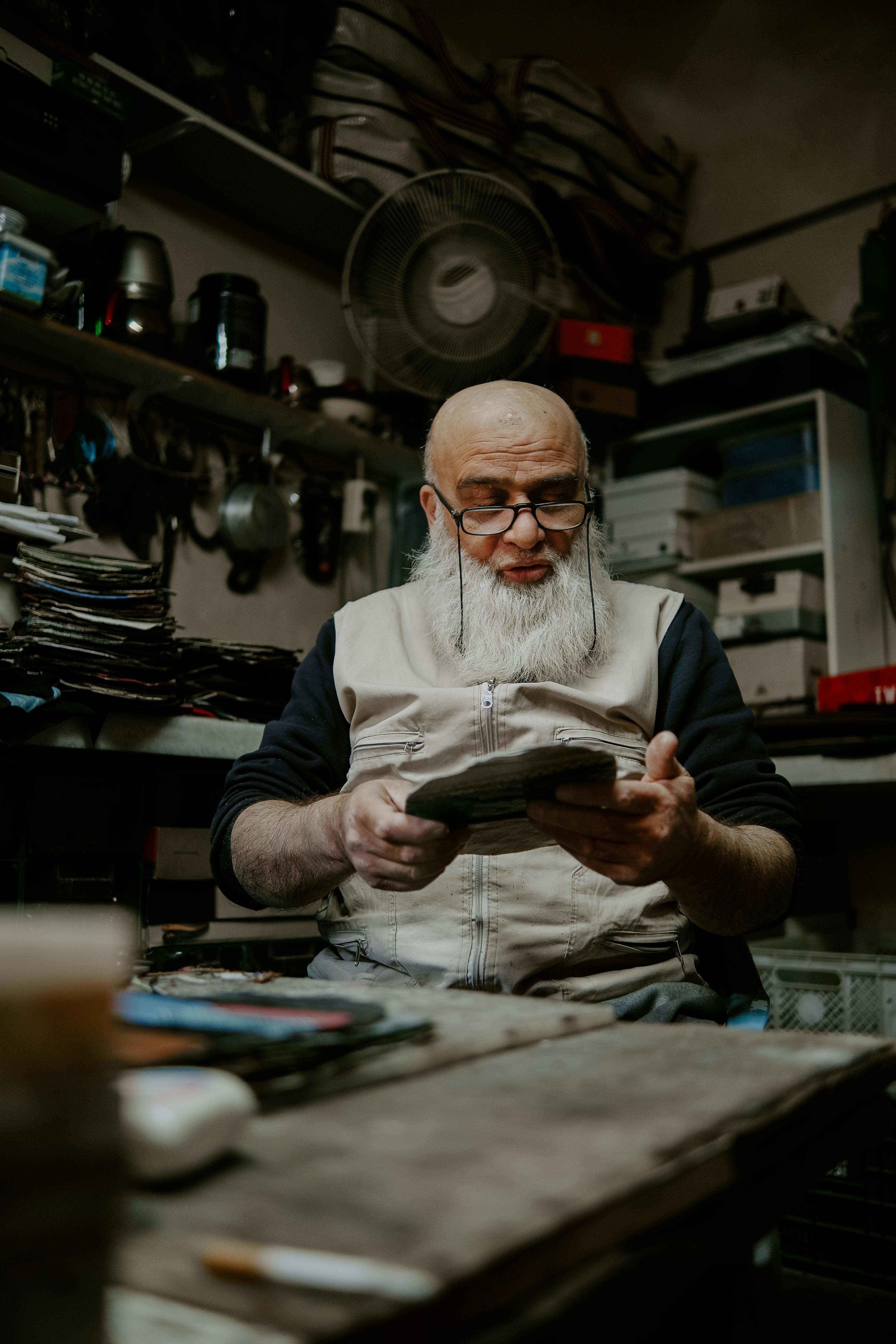 Elderly Shoemaker Sitting and Working · Free Stock Photo