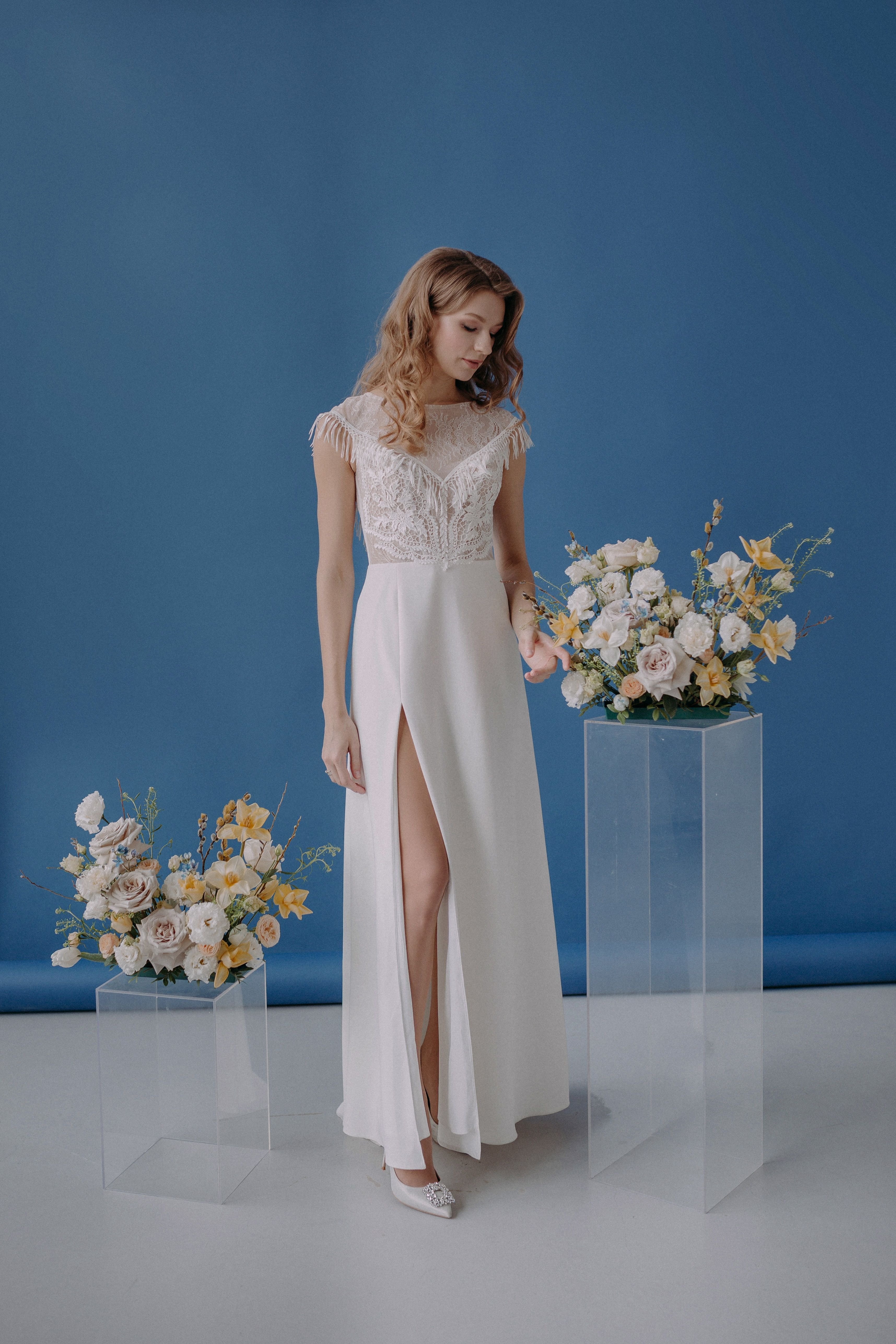 A Girl Staring at the Hanging Wedding Dress · Free Stock Photo