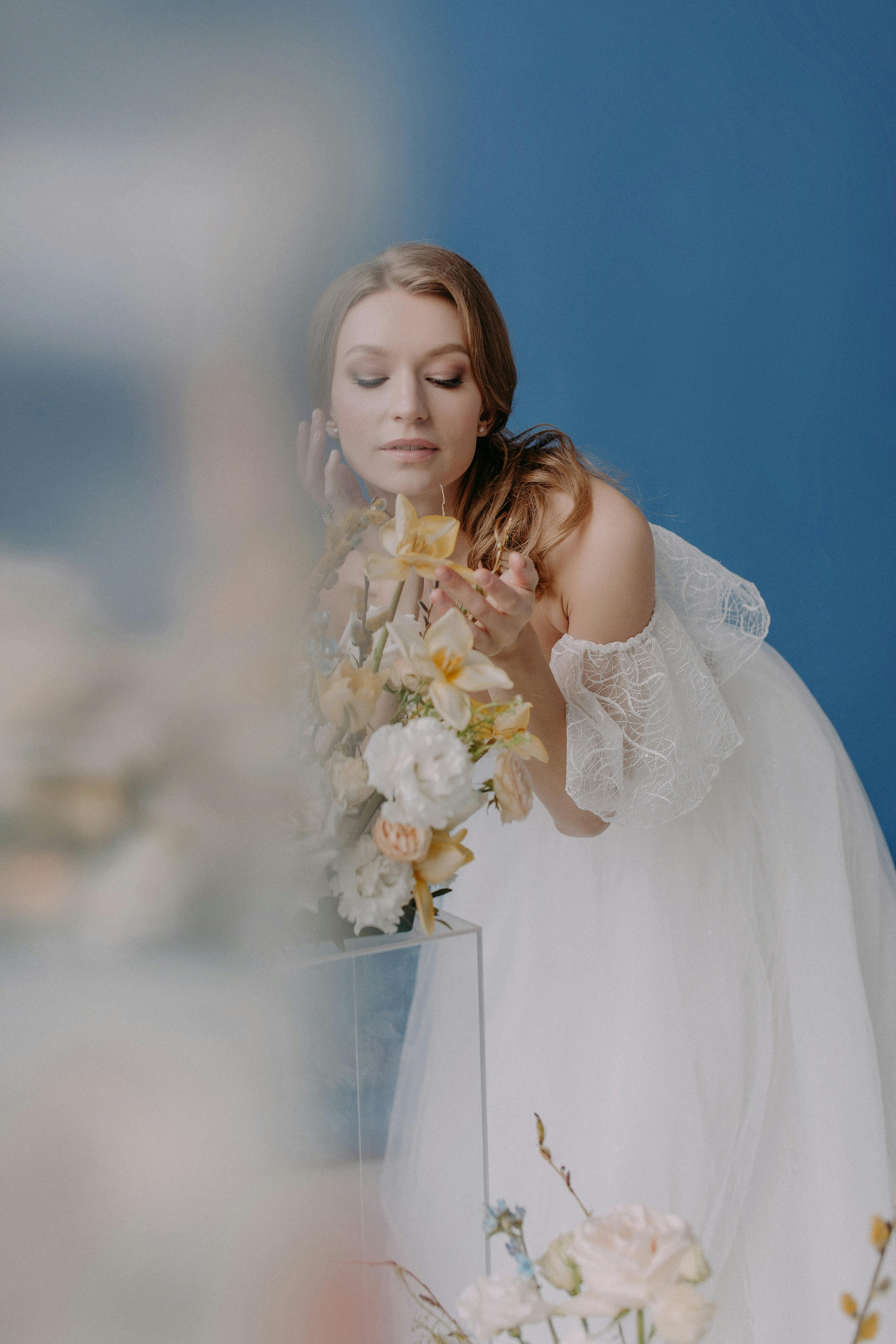 A Woman Smelling a Bunch of Roses · Free Stock Photo