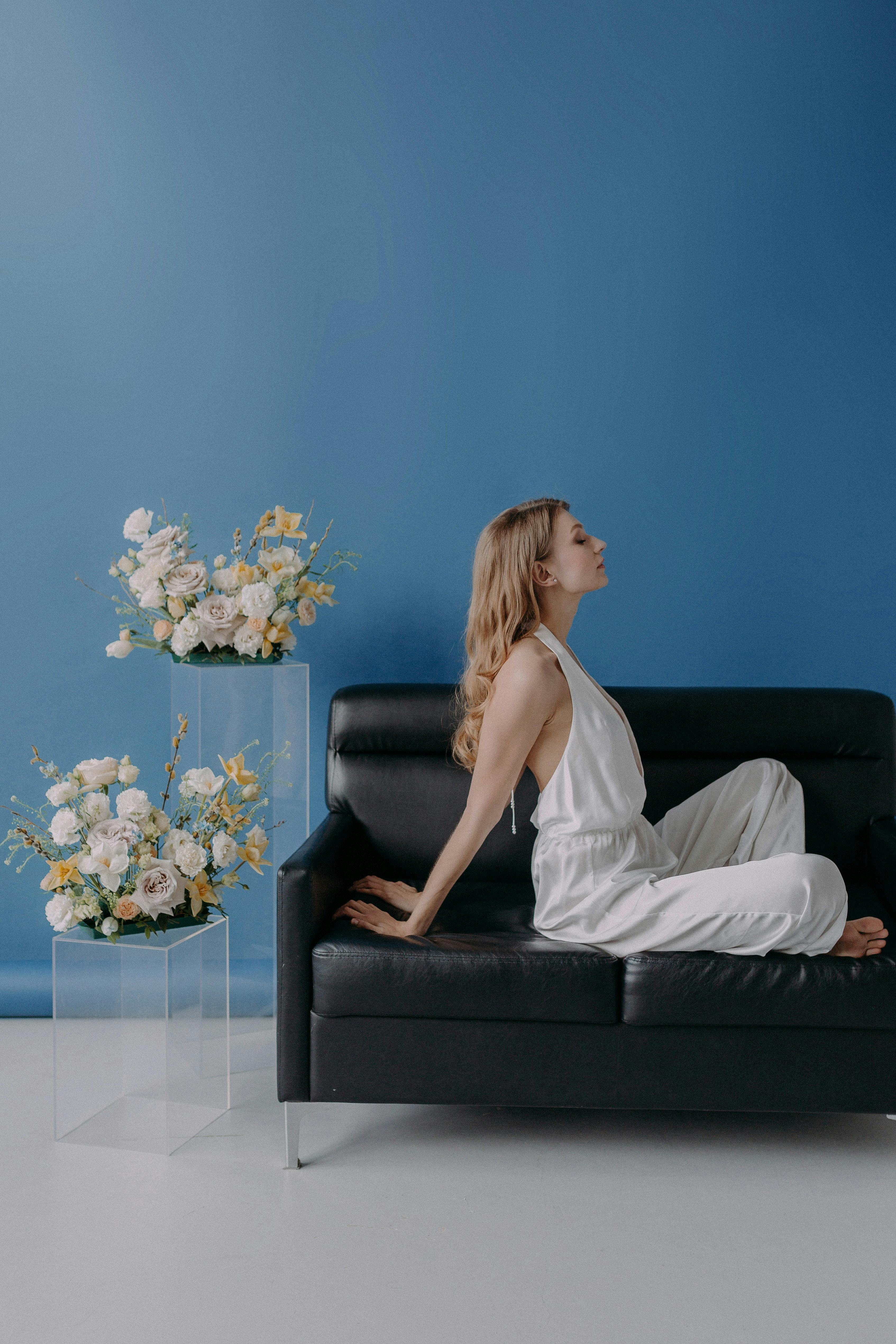 Woman Sitting on a Leather Sofa · Free Stock Photo