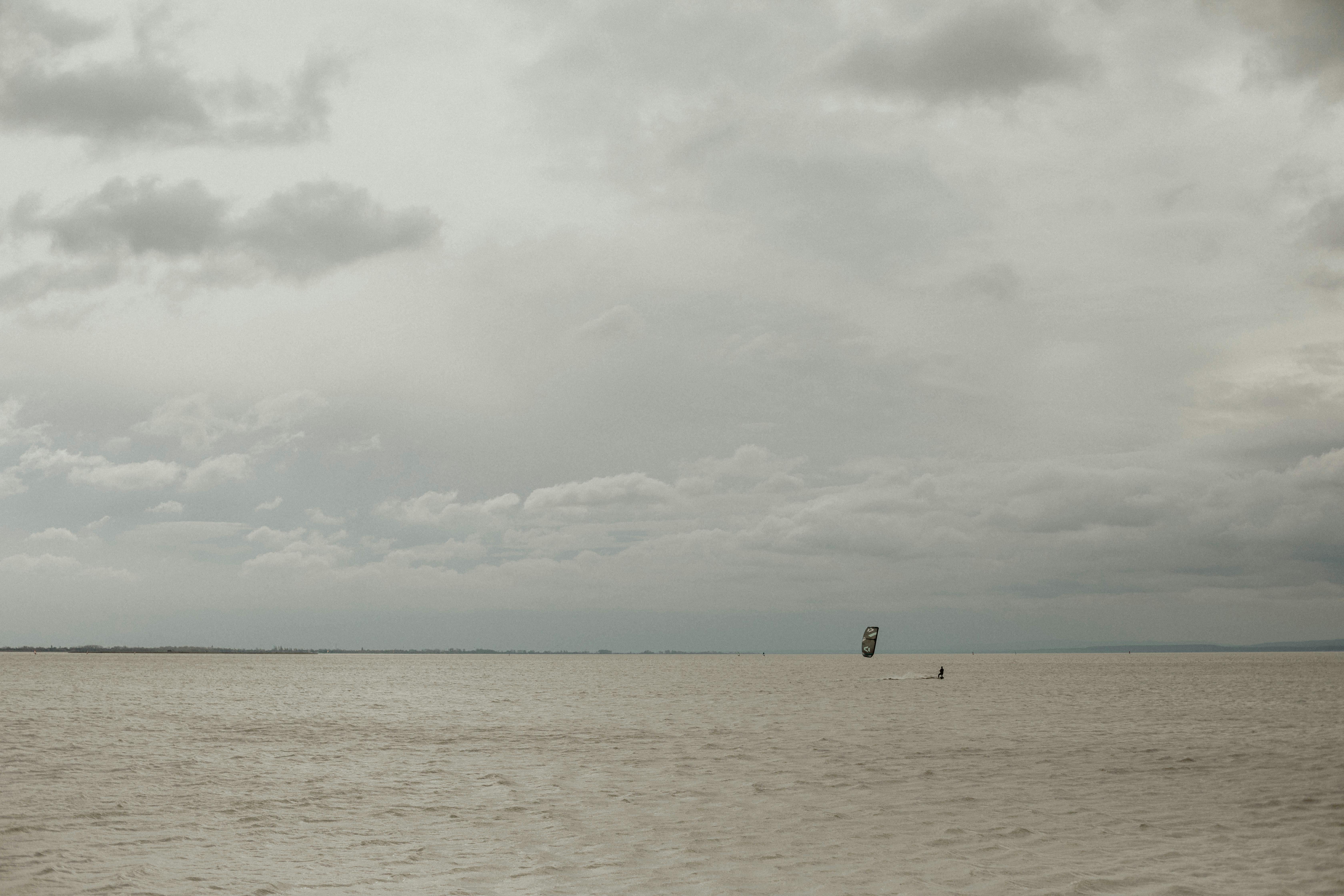 Sail on Sea near Shore under Clouds · Free Stock Photo