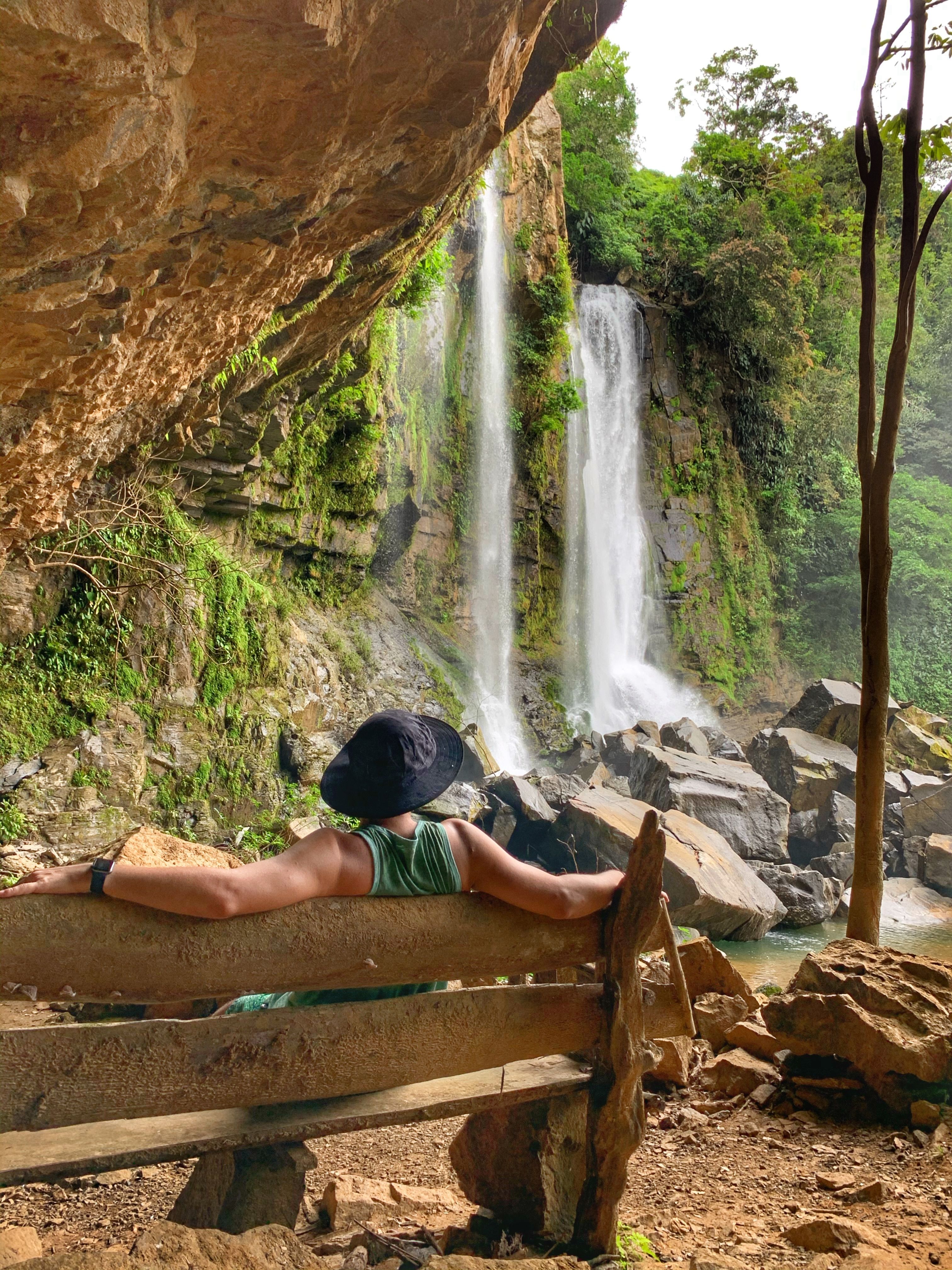 Person Sitting on Bench Overlooking Waterfall · Free Stock Photo