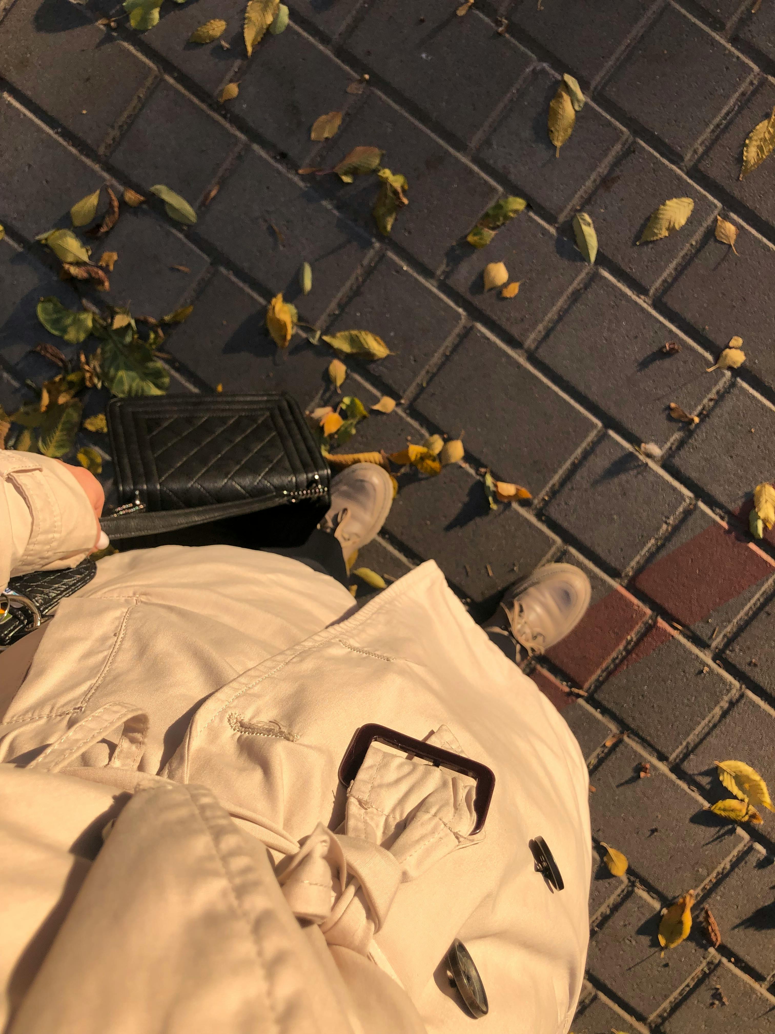 Girl in Trench Standing on Fall Ground · Free Stock Photo