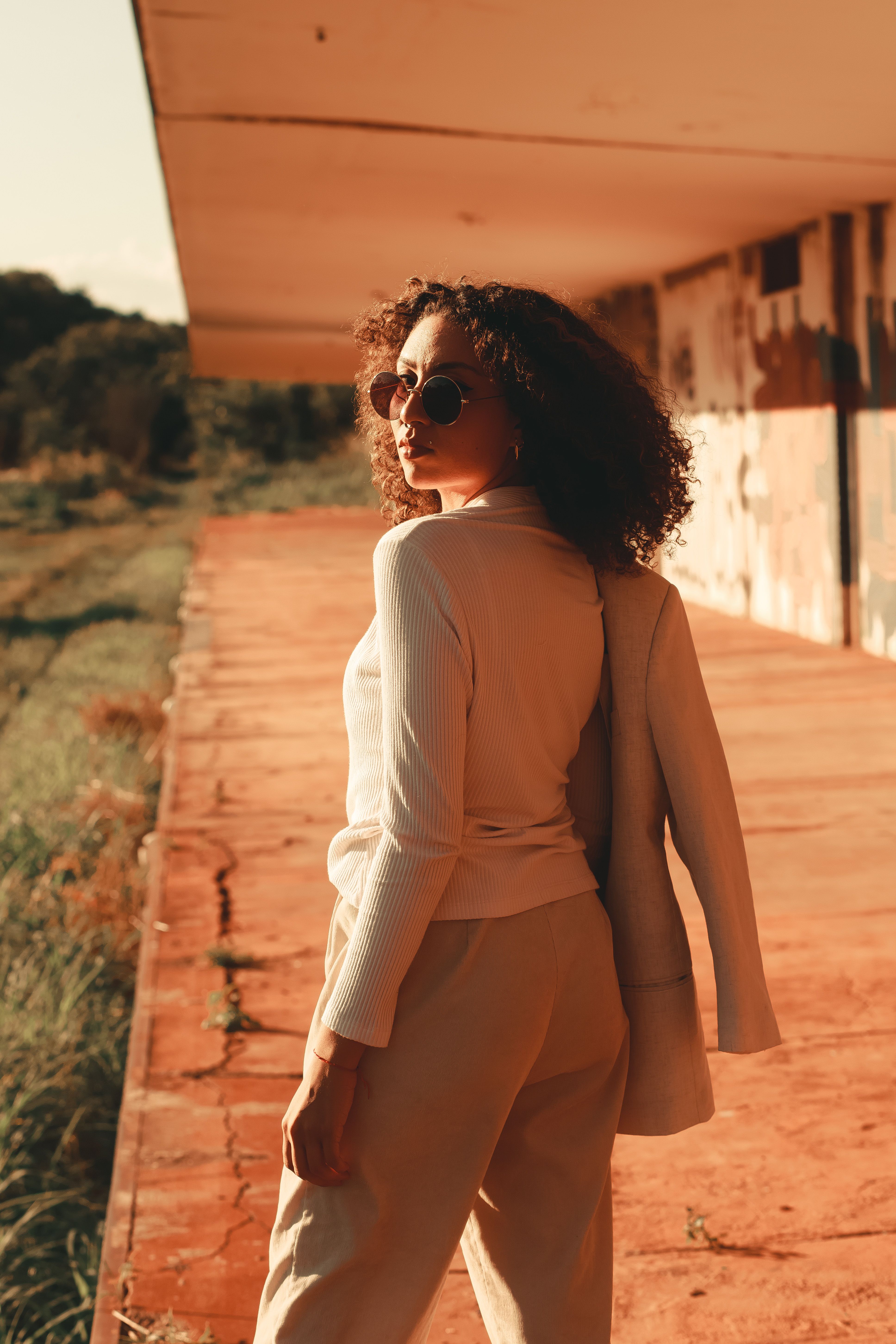 A Stylish Woman Looking Over Her Shoulder · Free Stock Photo