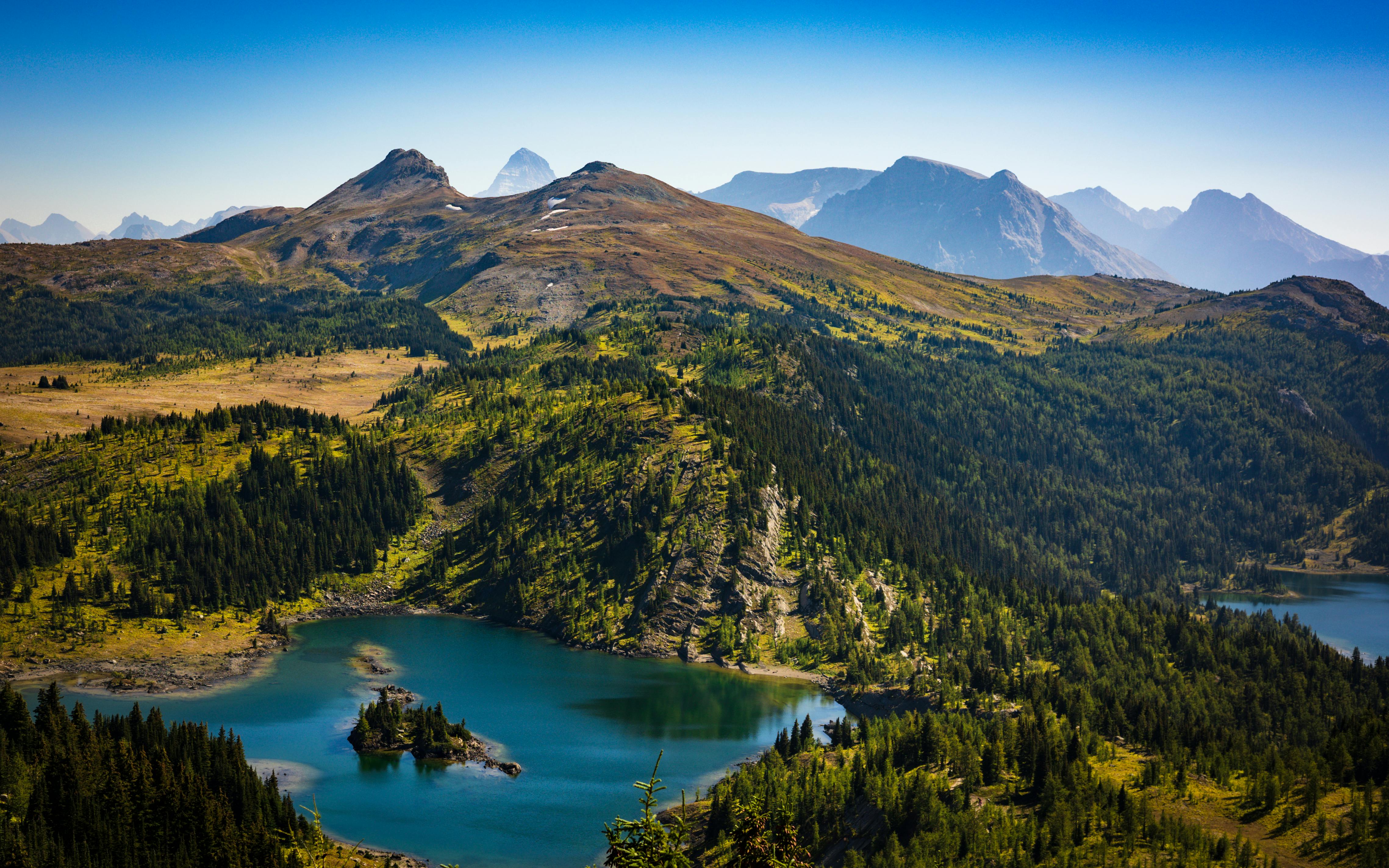 A Green Mountain with a Lake Under Blue Sky · Free Stock Photo