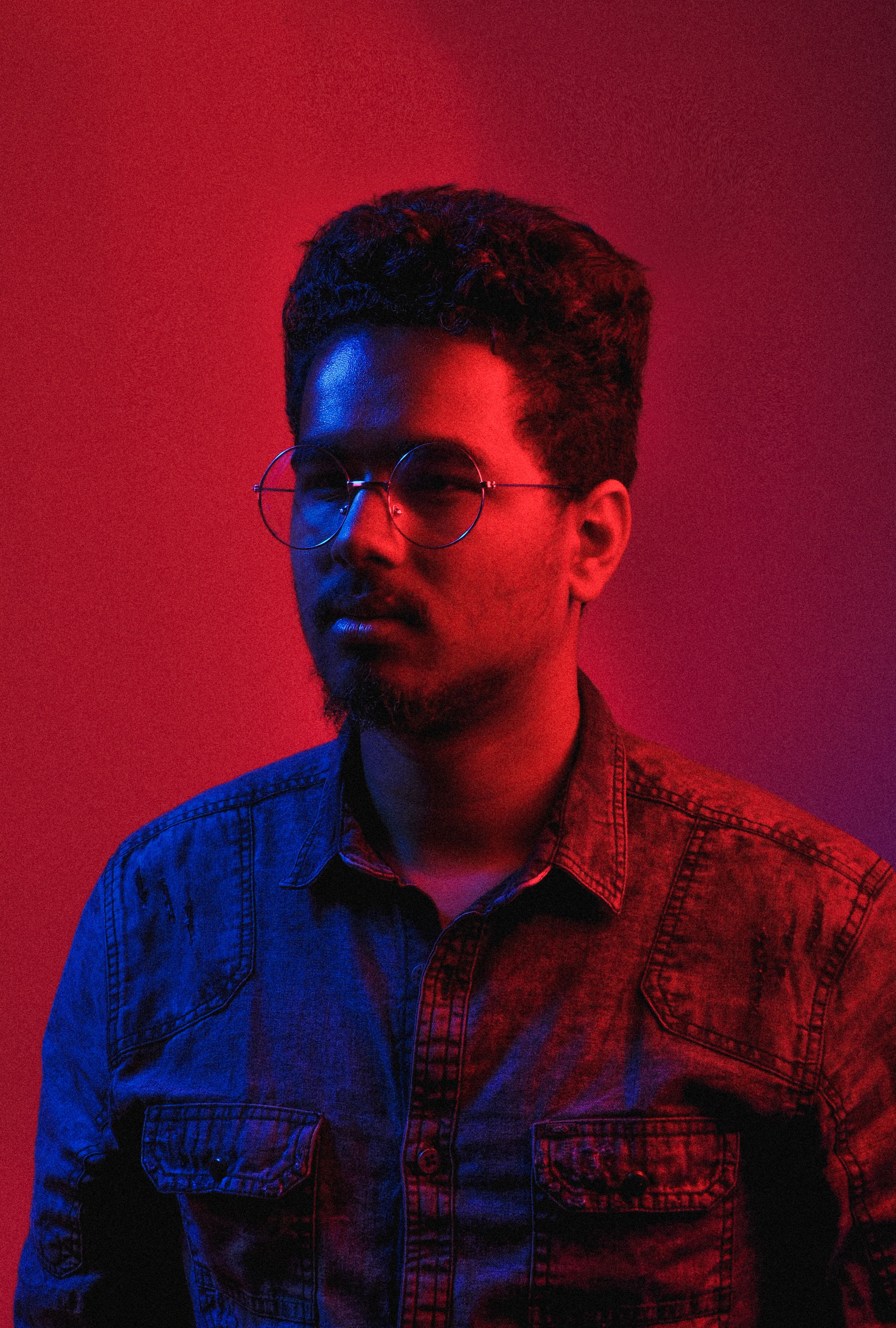 A of a Man Wearing a Denim Jacket in a Red and Blue Lighting · Free ...