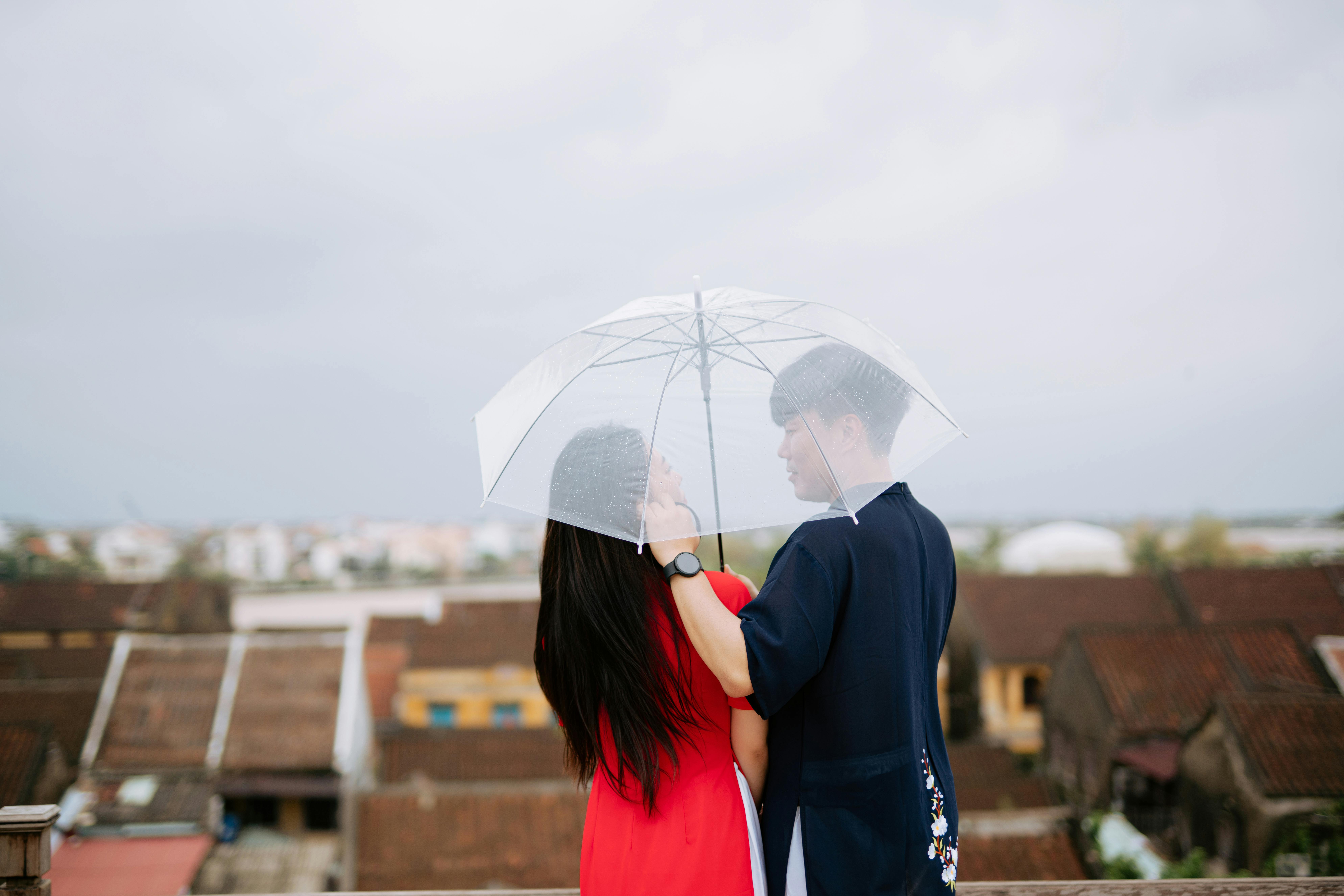 Photo of a Man and a Woman Under an Umbrella · Free Stock Photo