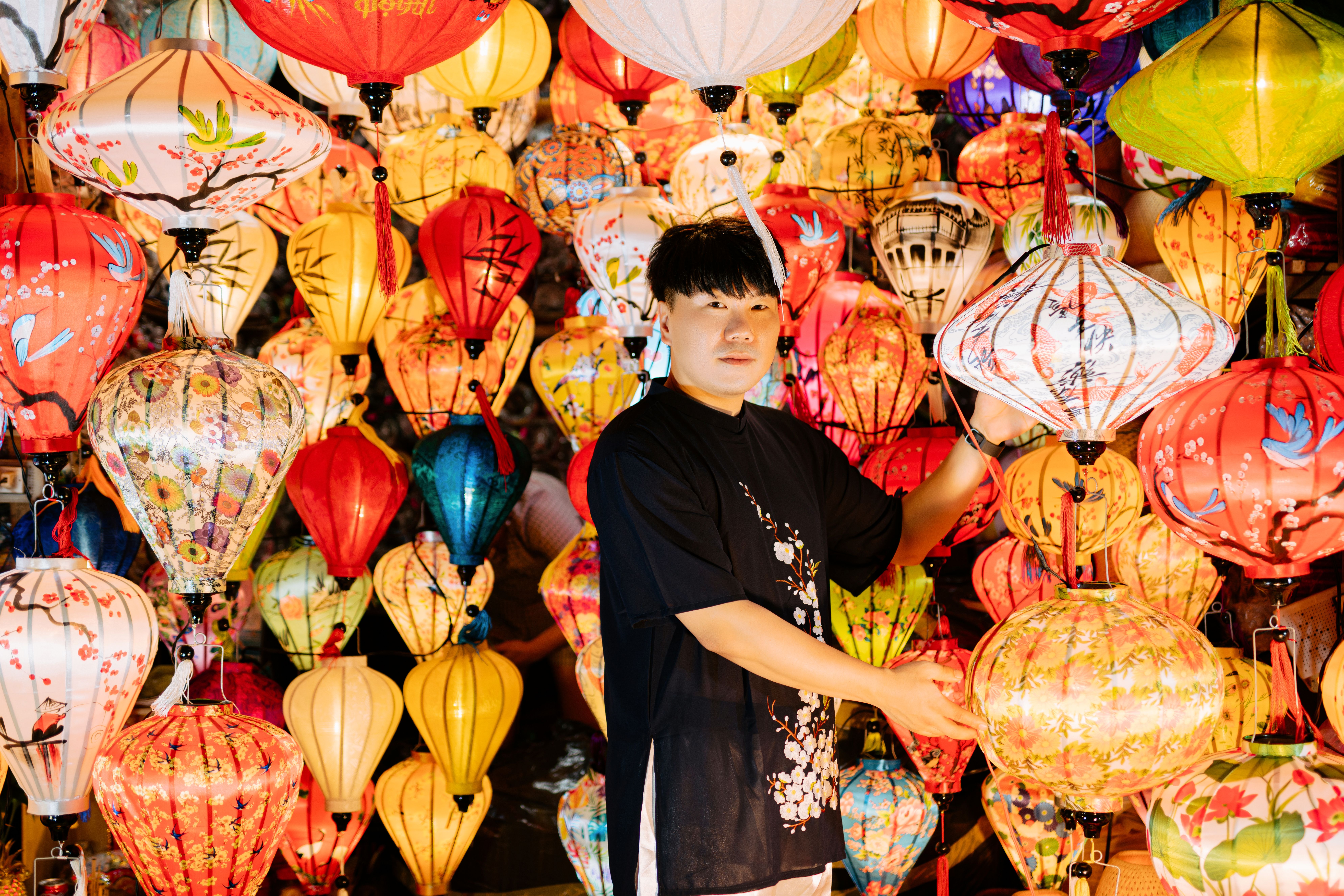 Photo of a Man Touching Lanterns · Free Stock Photo
