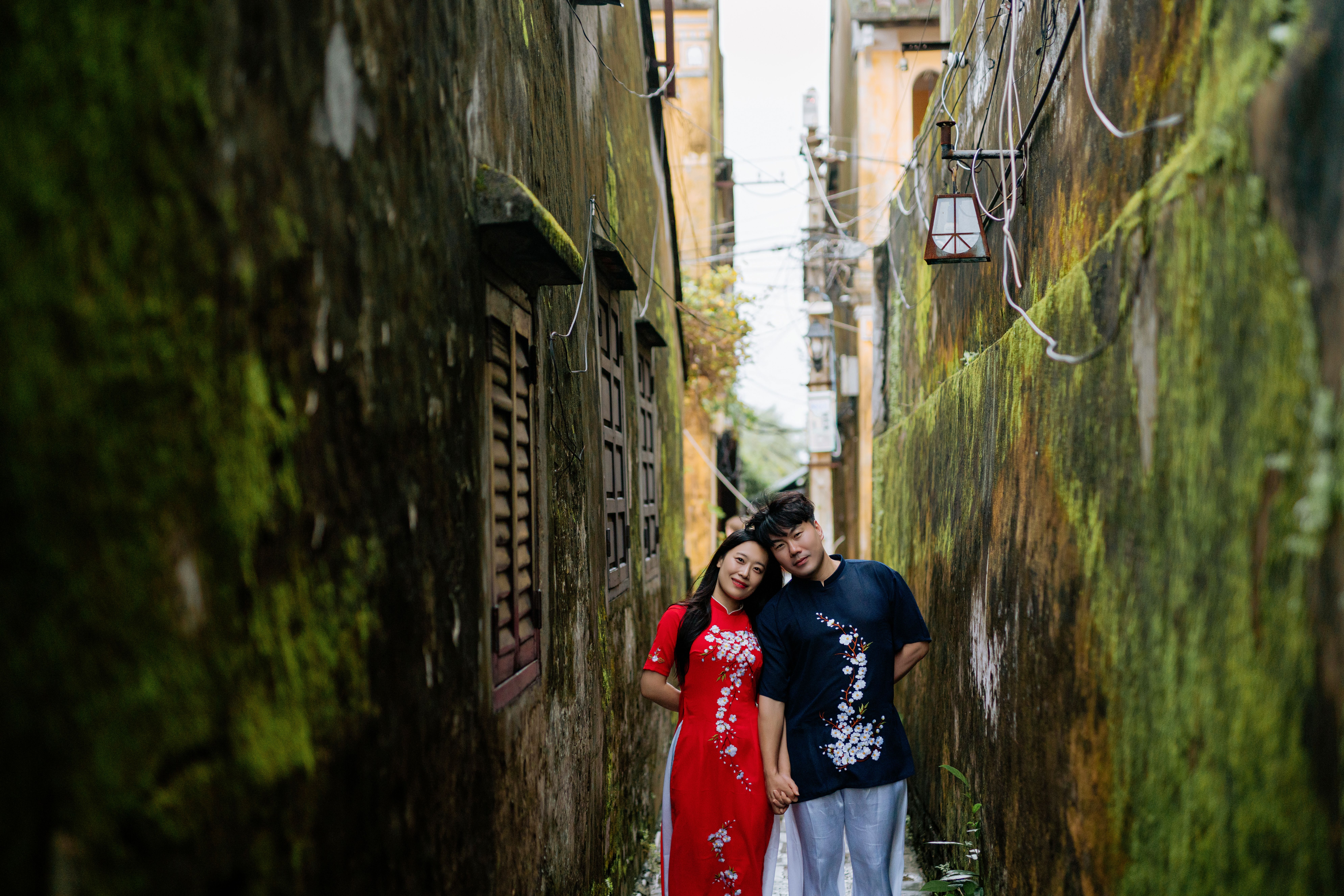 A Couple Holding Hands while Standing Between Concrete Walls · Free ...