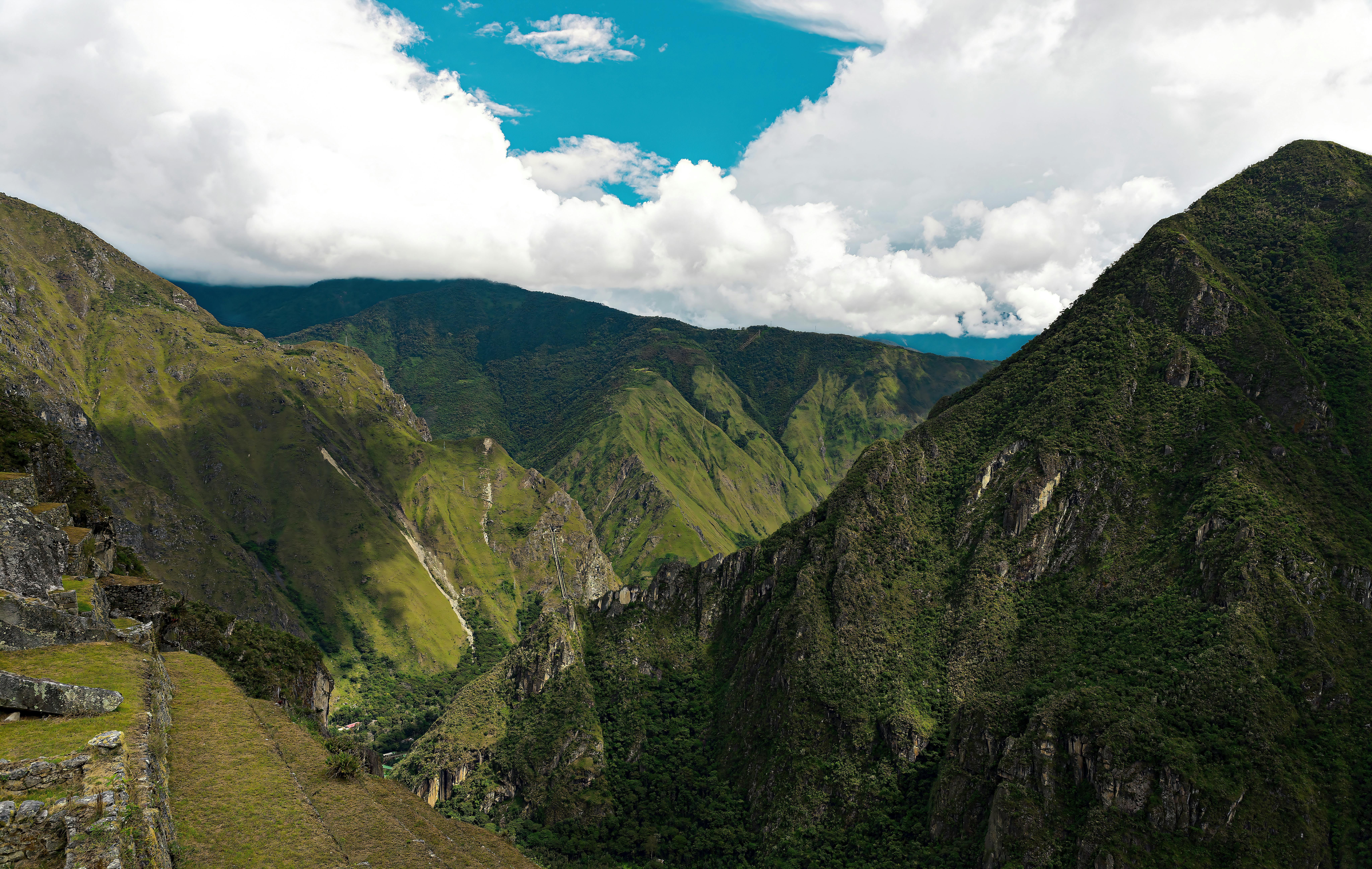 Green Mountain Ranges Under White Clouds · Free Stock Photo