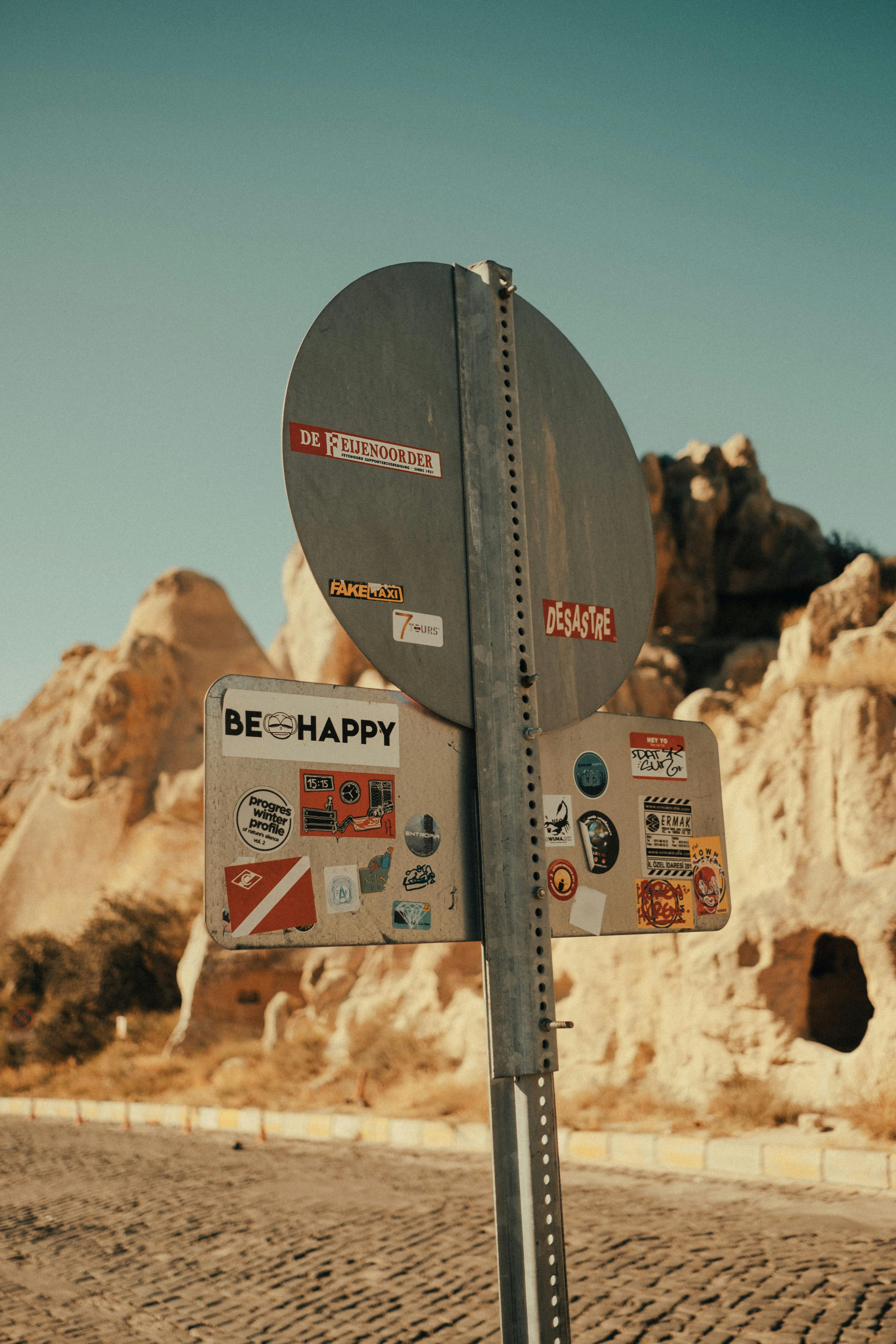 A Stainless Street Sign Near Rock Formations · Free Stock Photo
