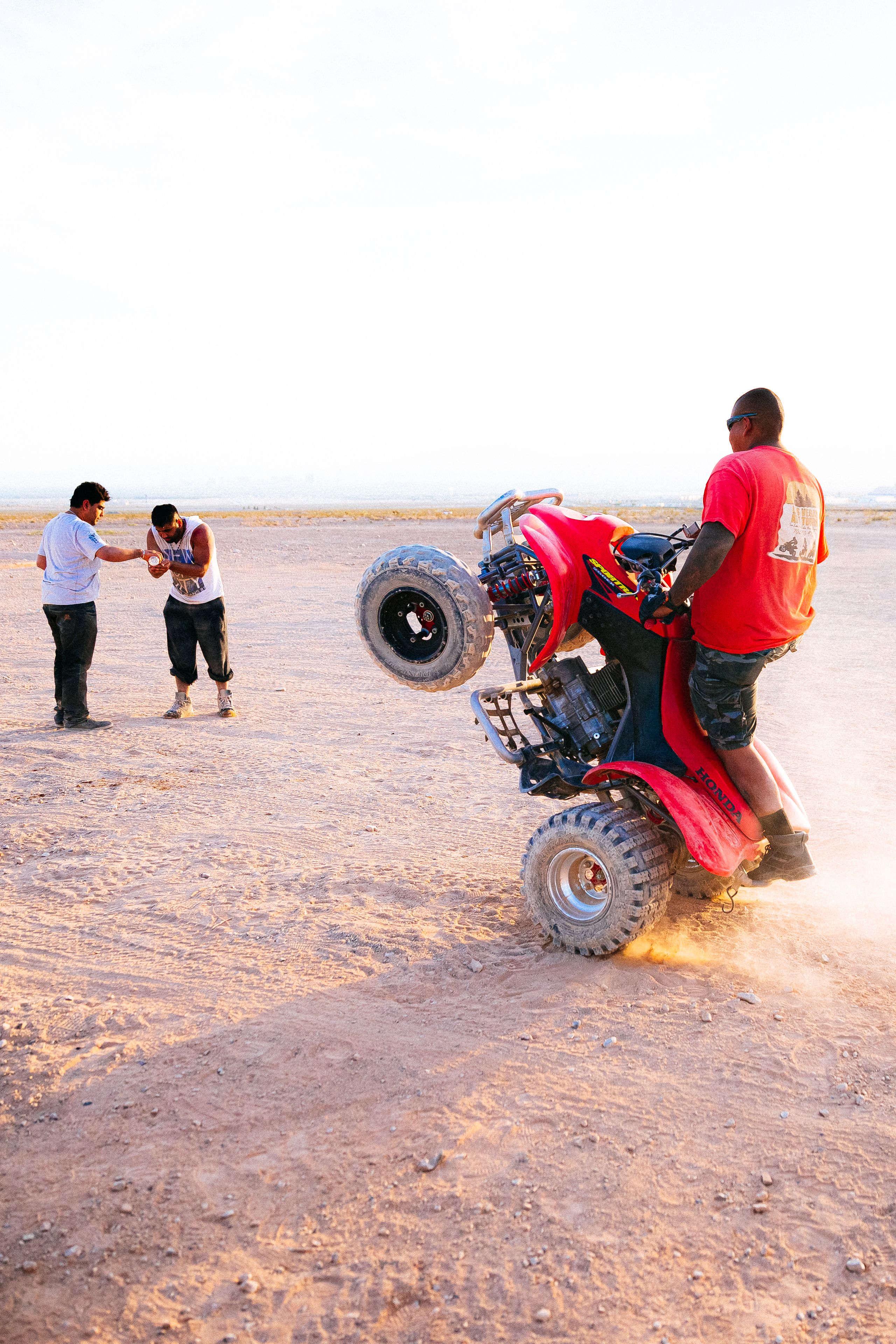 A Woman Standing on a Quad Bike in the Desert · Free Stock Photo