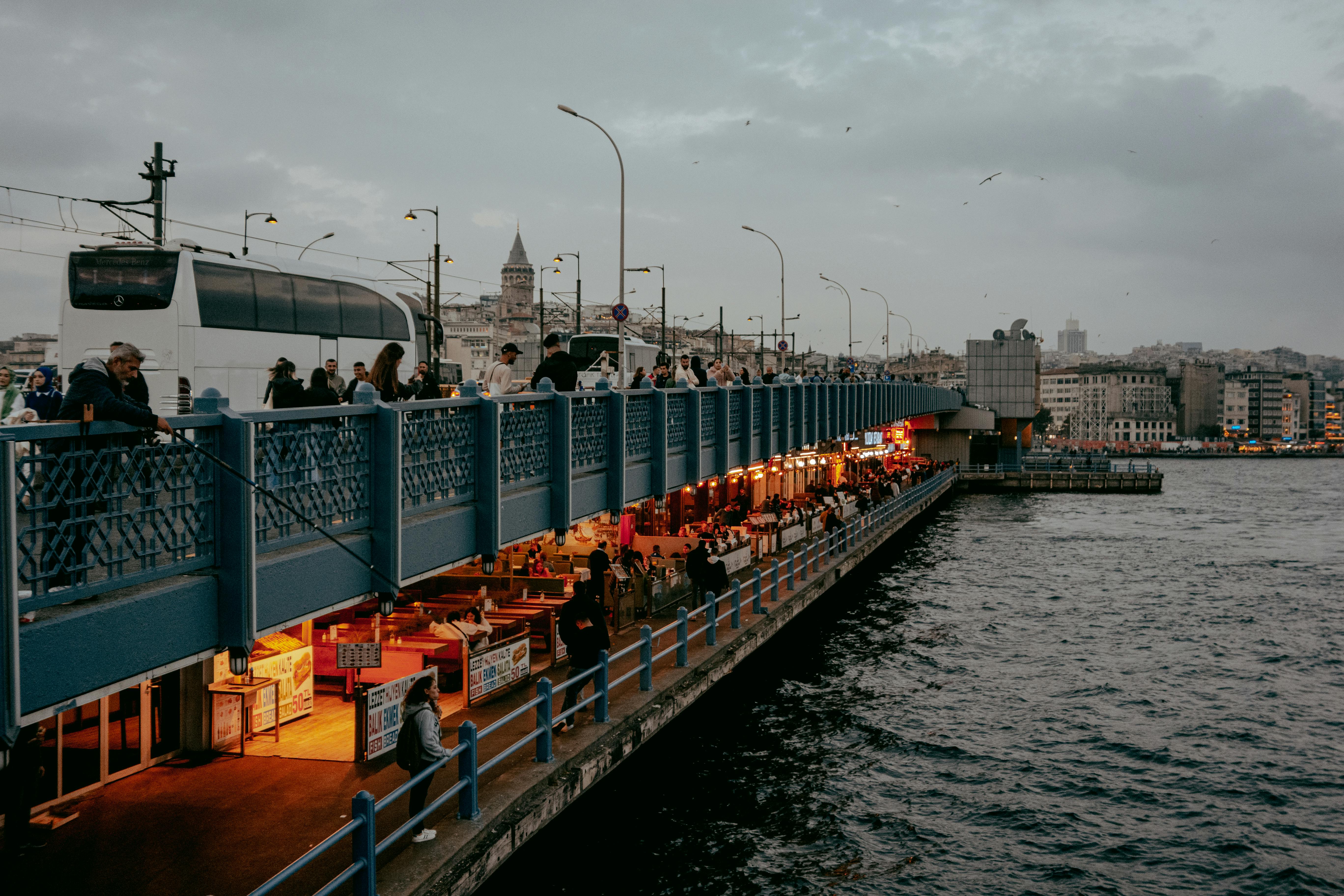 People on Bridge near River on Sunset · Free Stock Photo