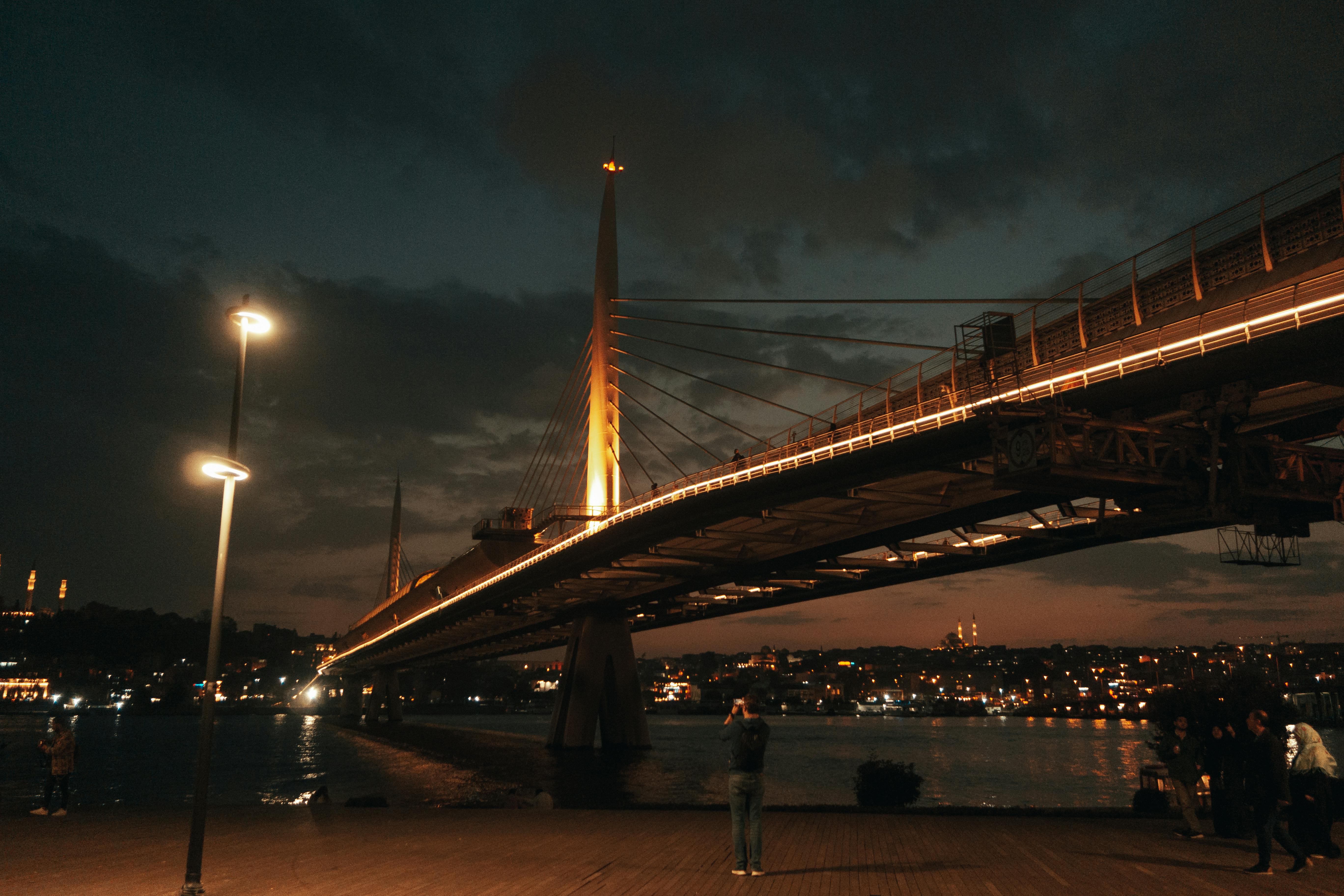 People Taking Photos and Walking by the Golden Horn Bridge at Night ...
