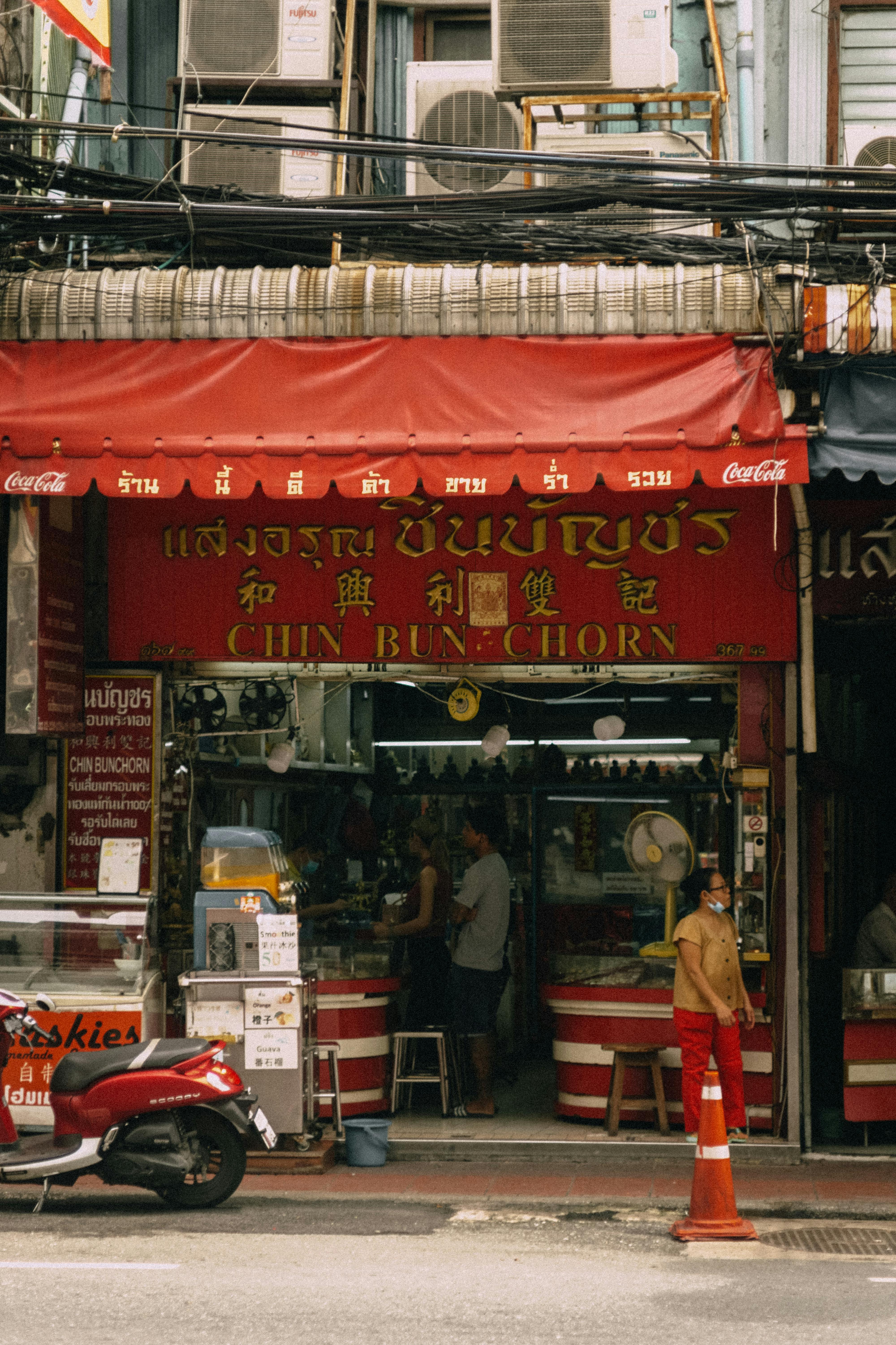 Red and White Store Front with People Inside · Free Stock Photo